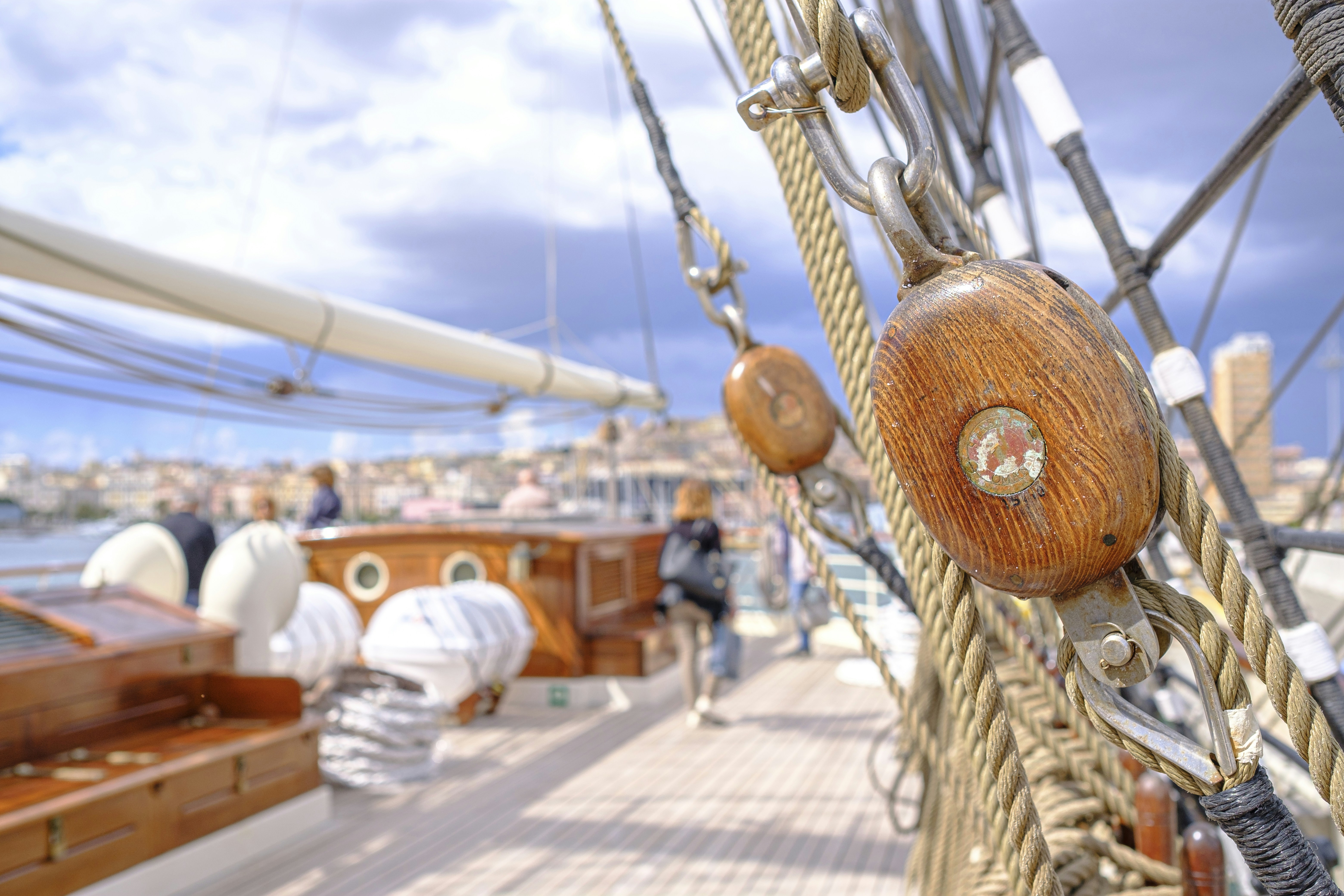 Weathered Pulley Close-Up: Threads of Color on a Sailing Deck