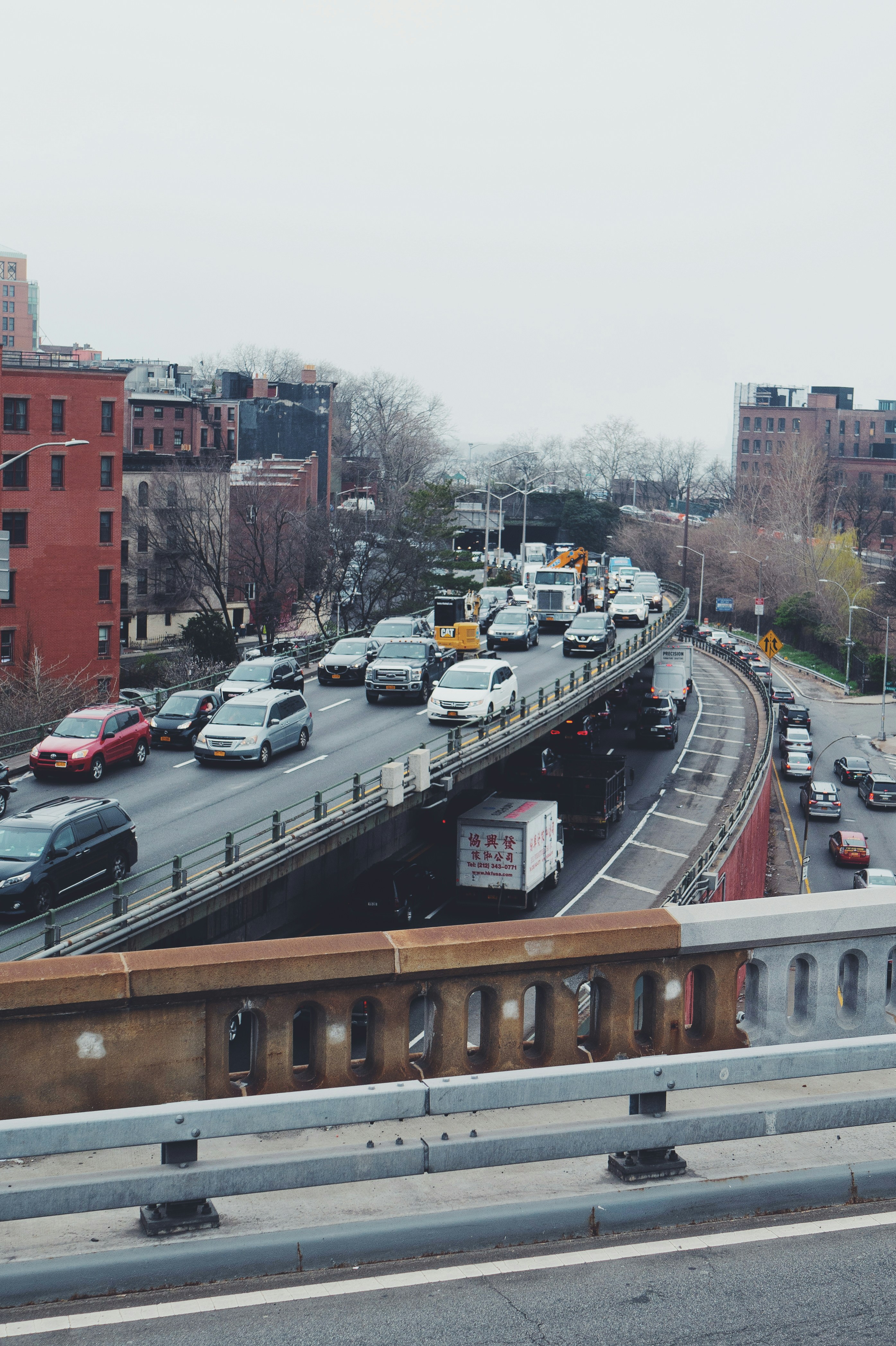 Traffic flows along a multi-level highway surrounded by urban architecture, showcasing the rhythm of city life.