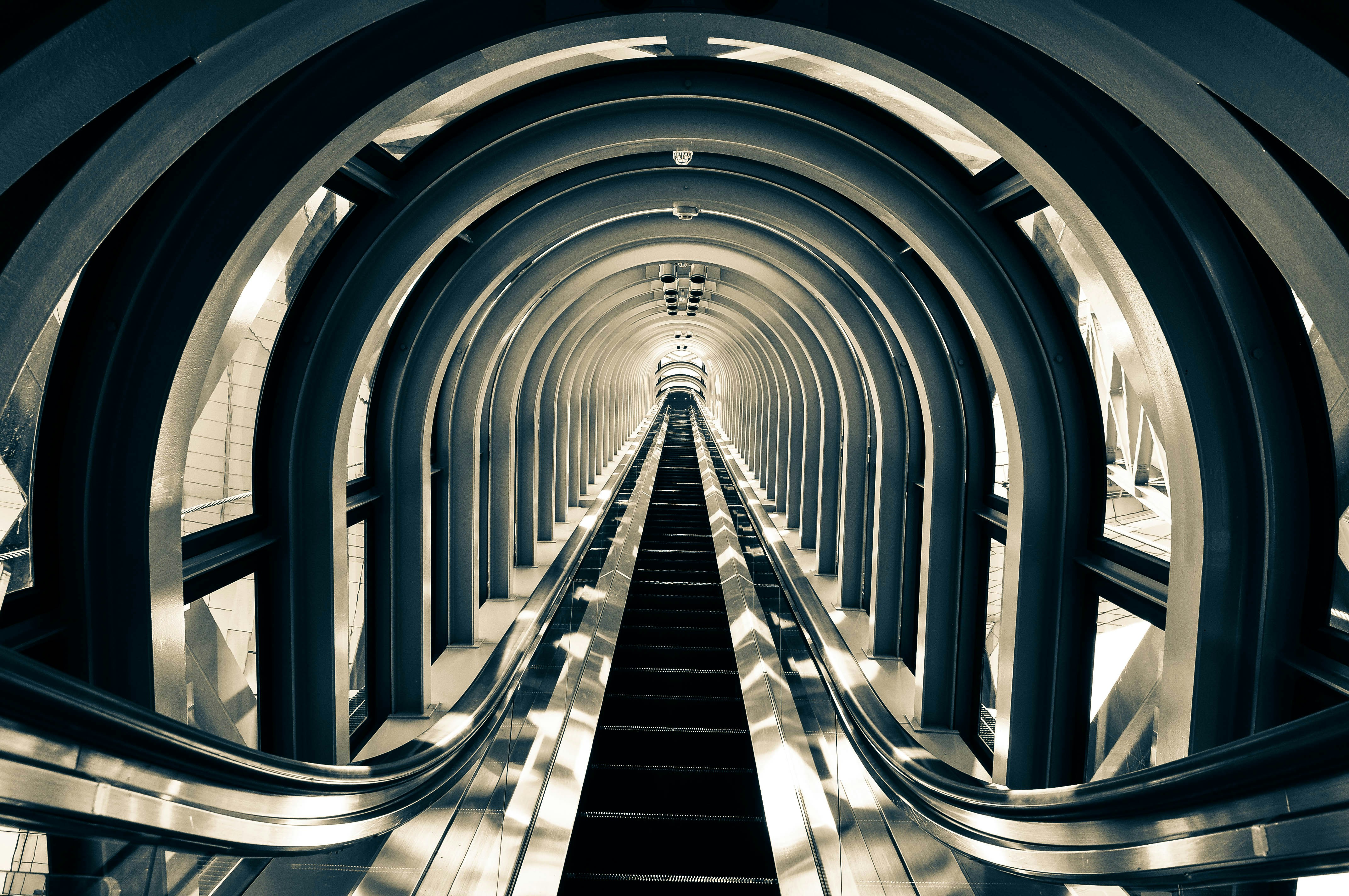 Grayscale photo of escalator with no people inside building photo ...