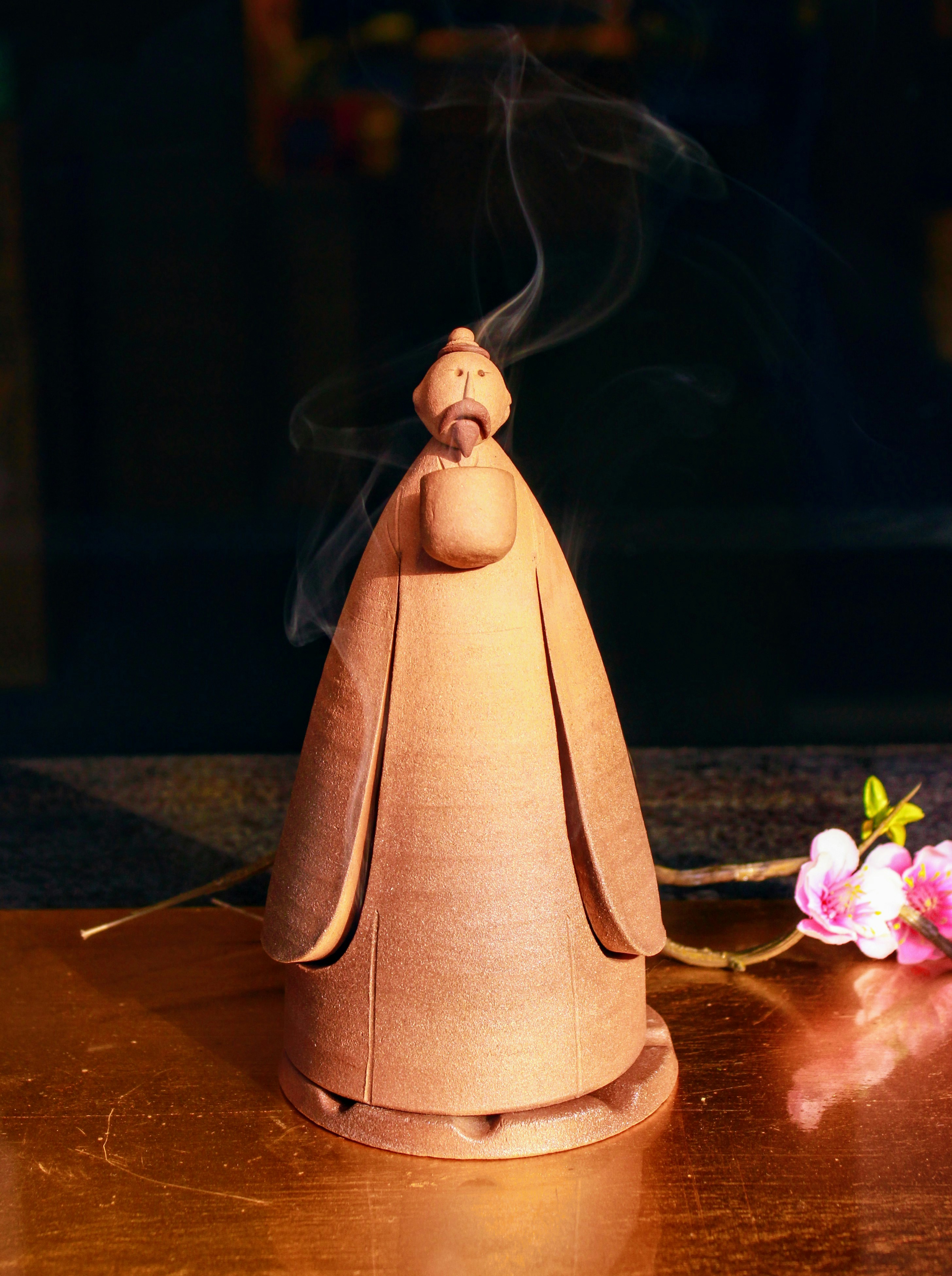 Ember Crown: A Cone-Wrapped Figure on a Copper Stage