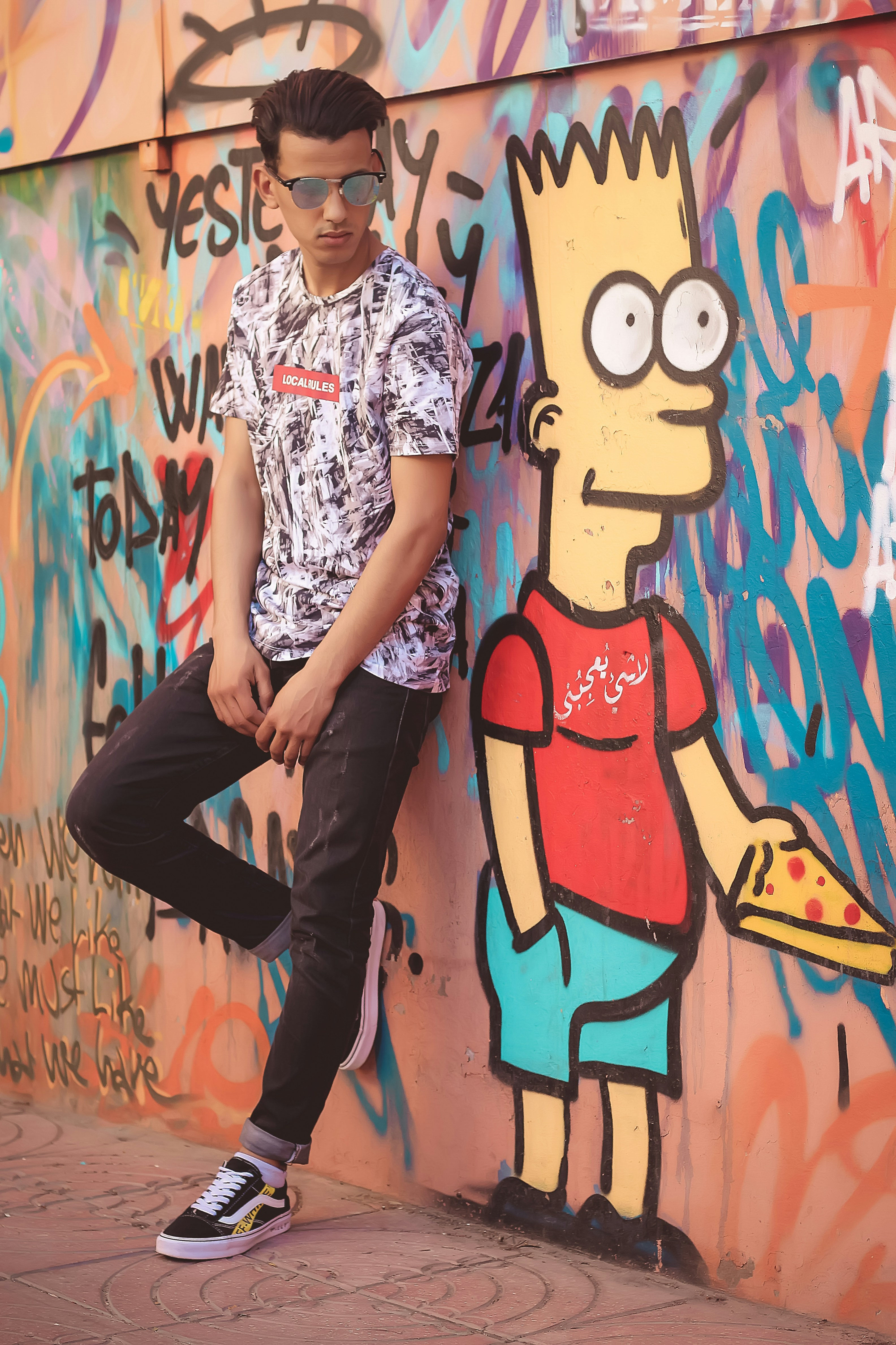 Man leaning on wall with Bart Simpson artwork photo – Free Human Image ...