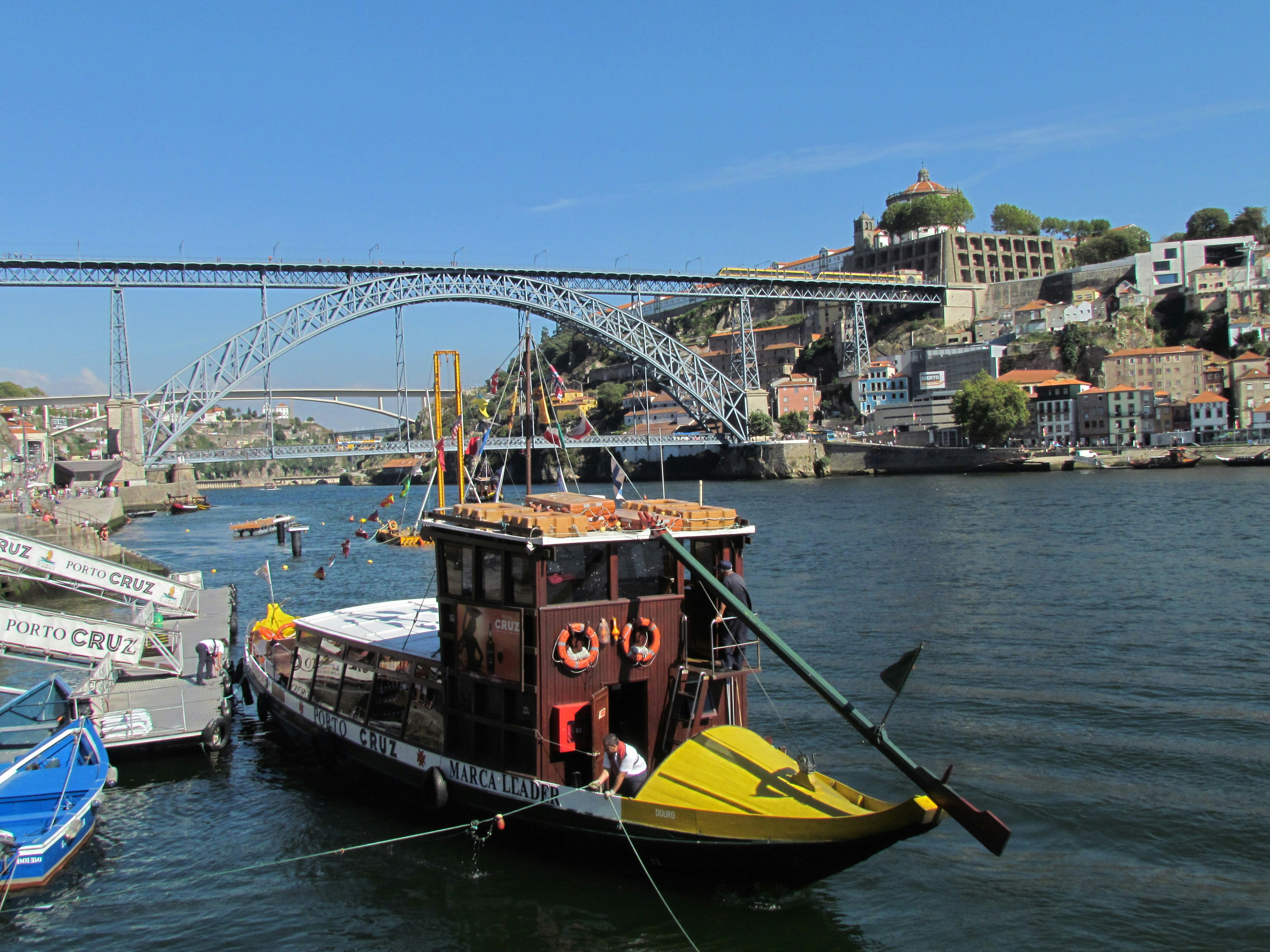 Yellow-Bowed Tug Anchored Before Porto’s Arched Bridge