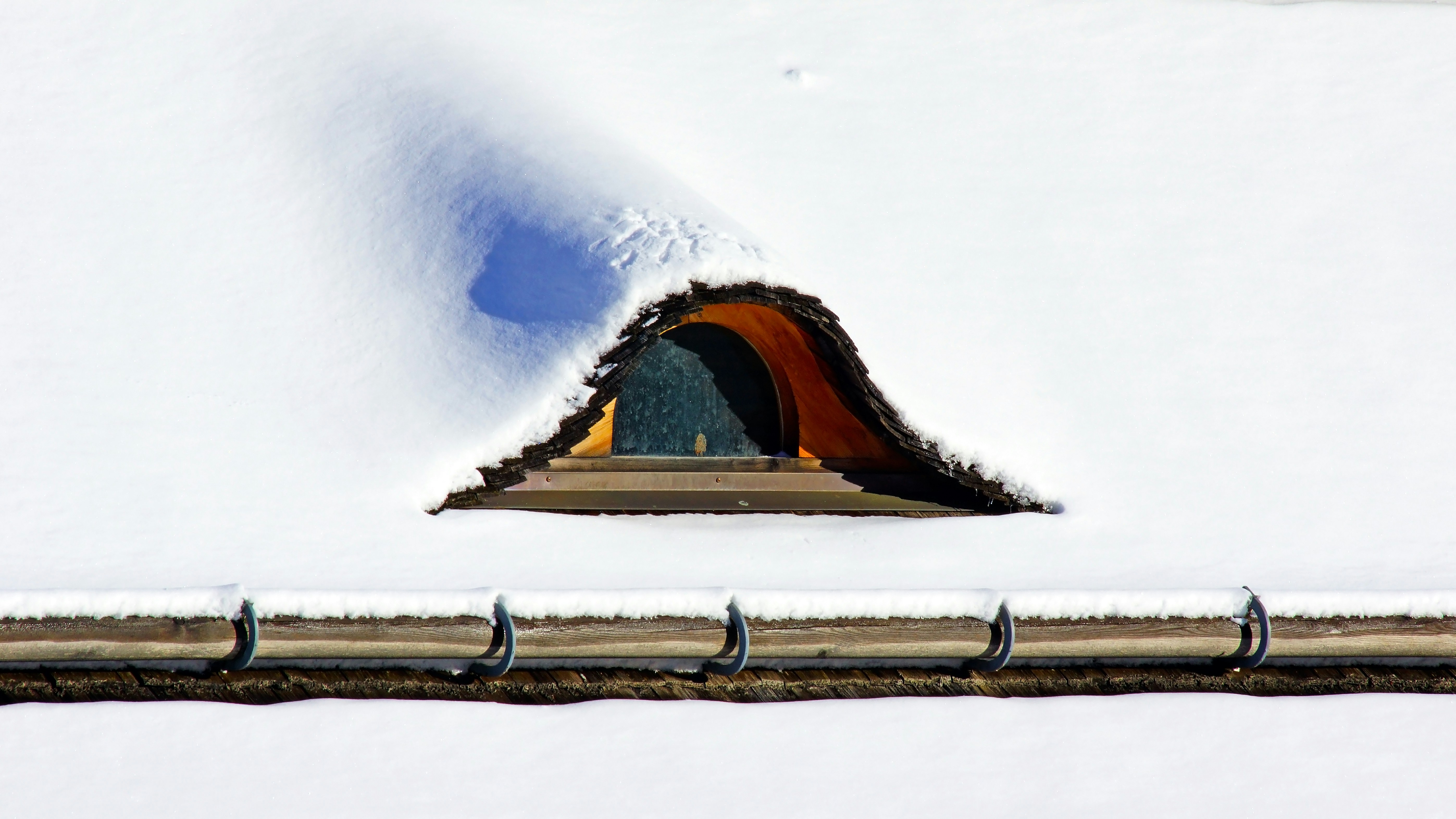 Dormer in the Snow: A Quiet Roofscape Framed by White