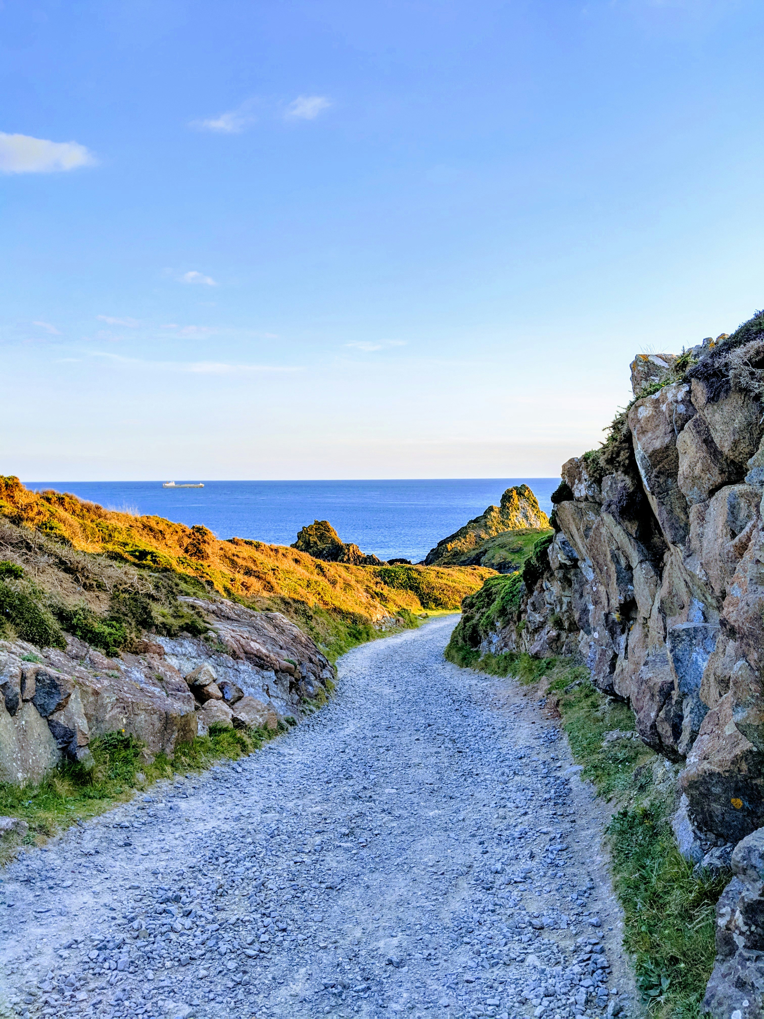 Coastal Pathway Between Weathered Rocks with Ocean Horizon