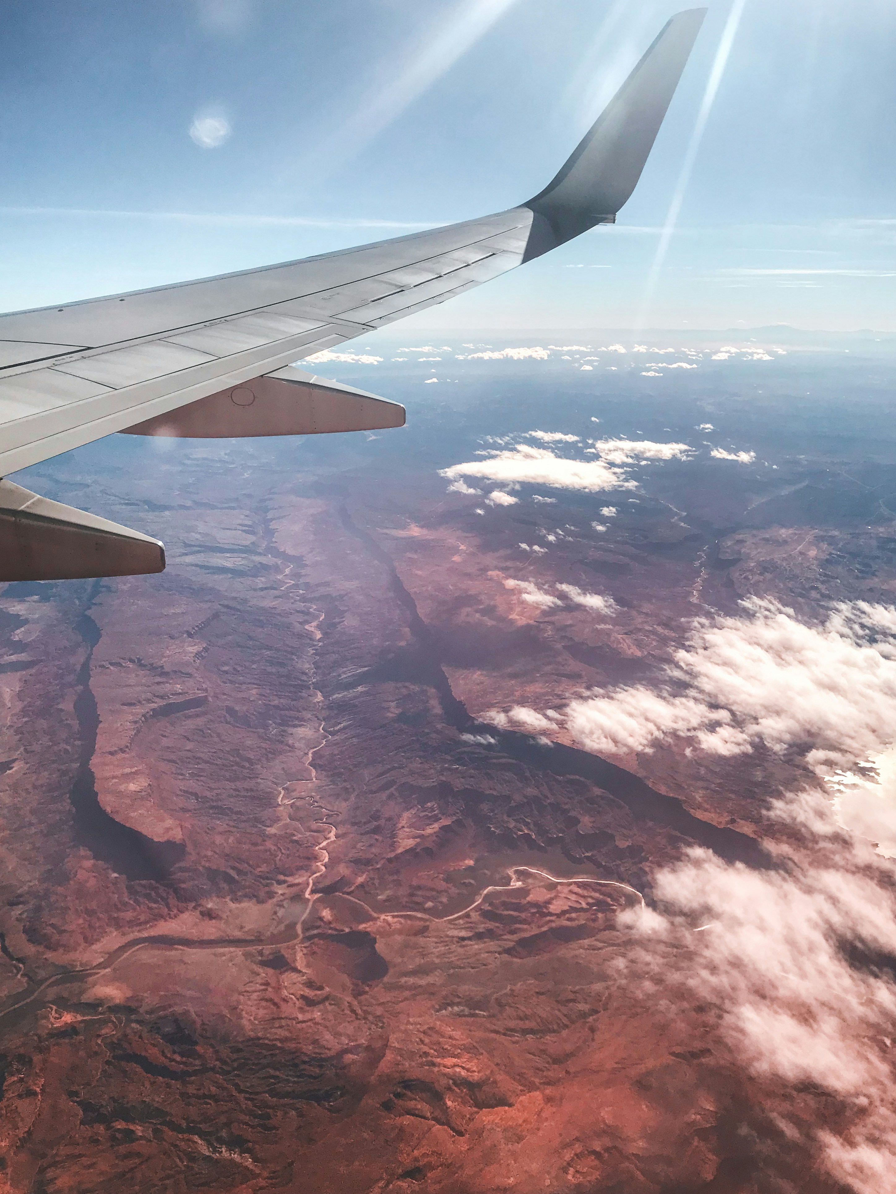 Wingtip Over the Rust-Red Canyon: An Aerial Window View