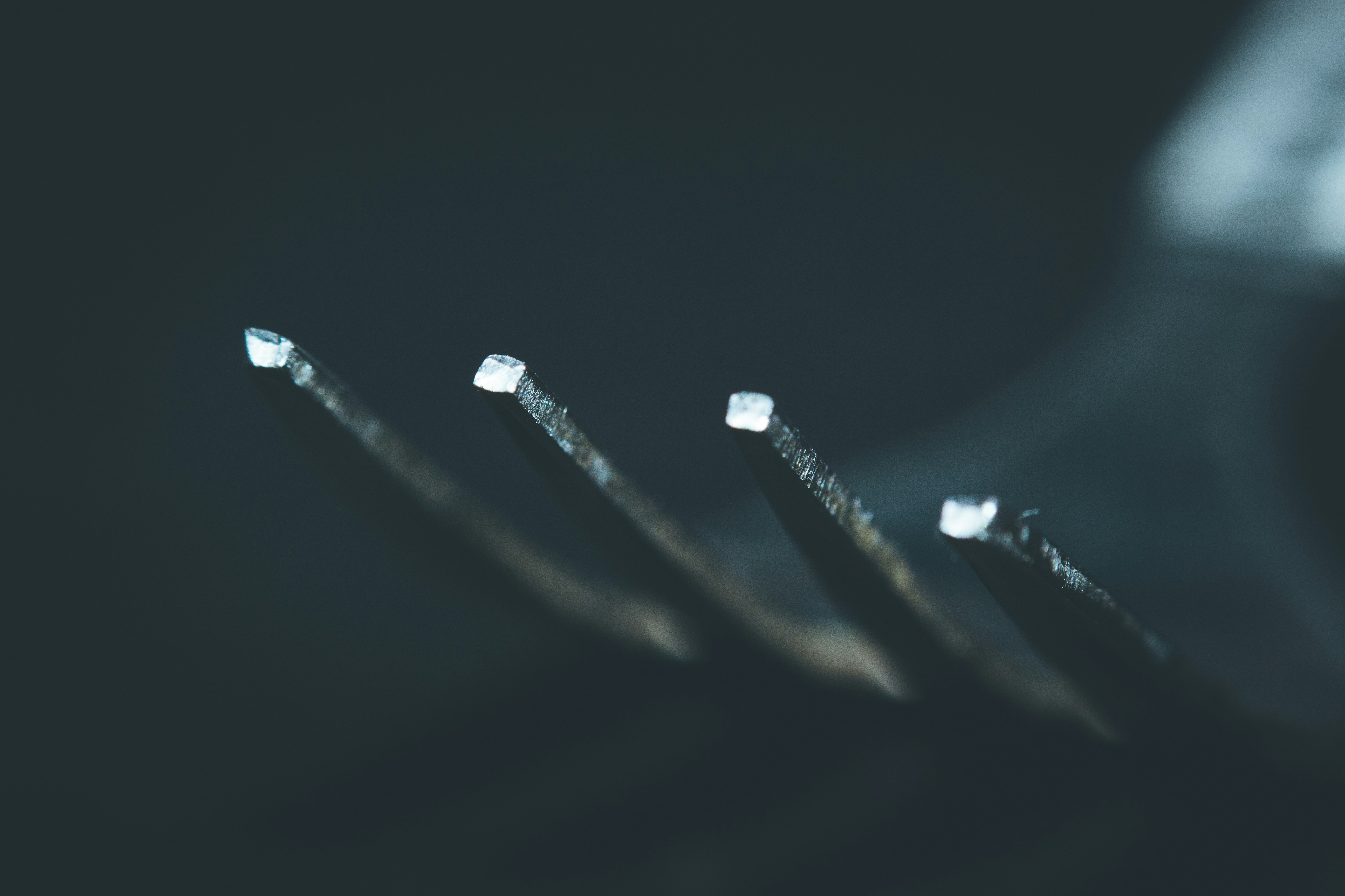 Edge Glints: A Close-Up Portrait of Pin Tips in Deep Blue