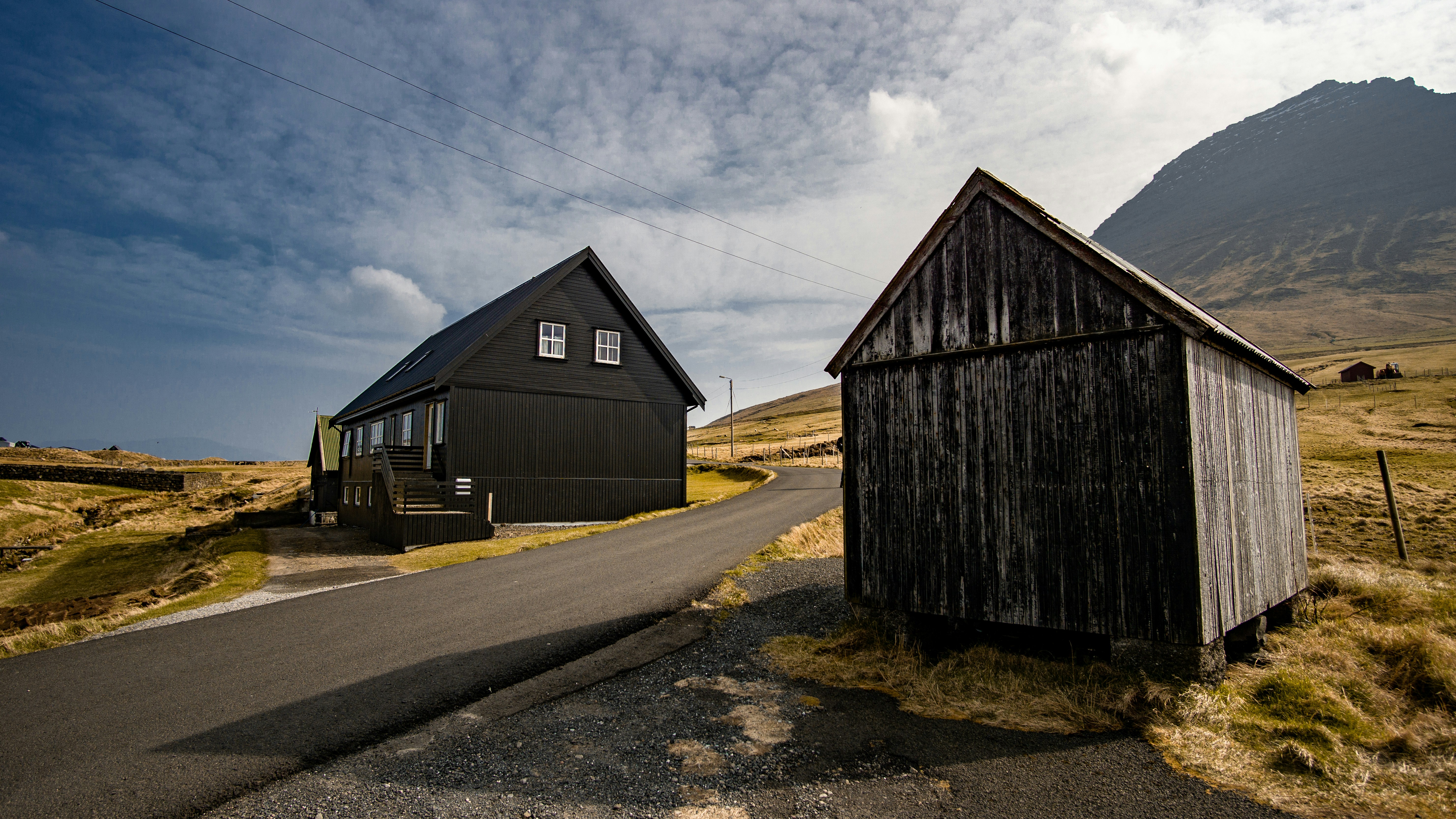 Ridge Road Between Weathered Outbuildings