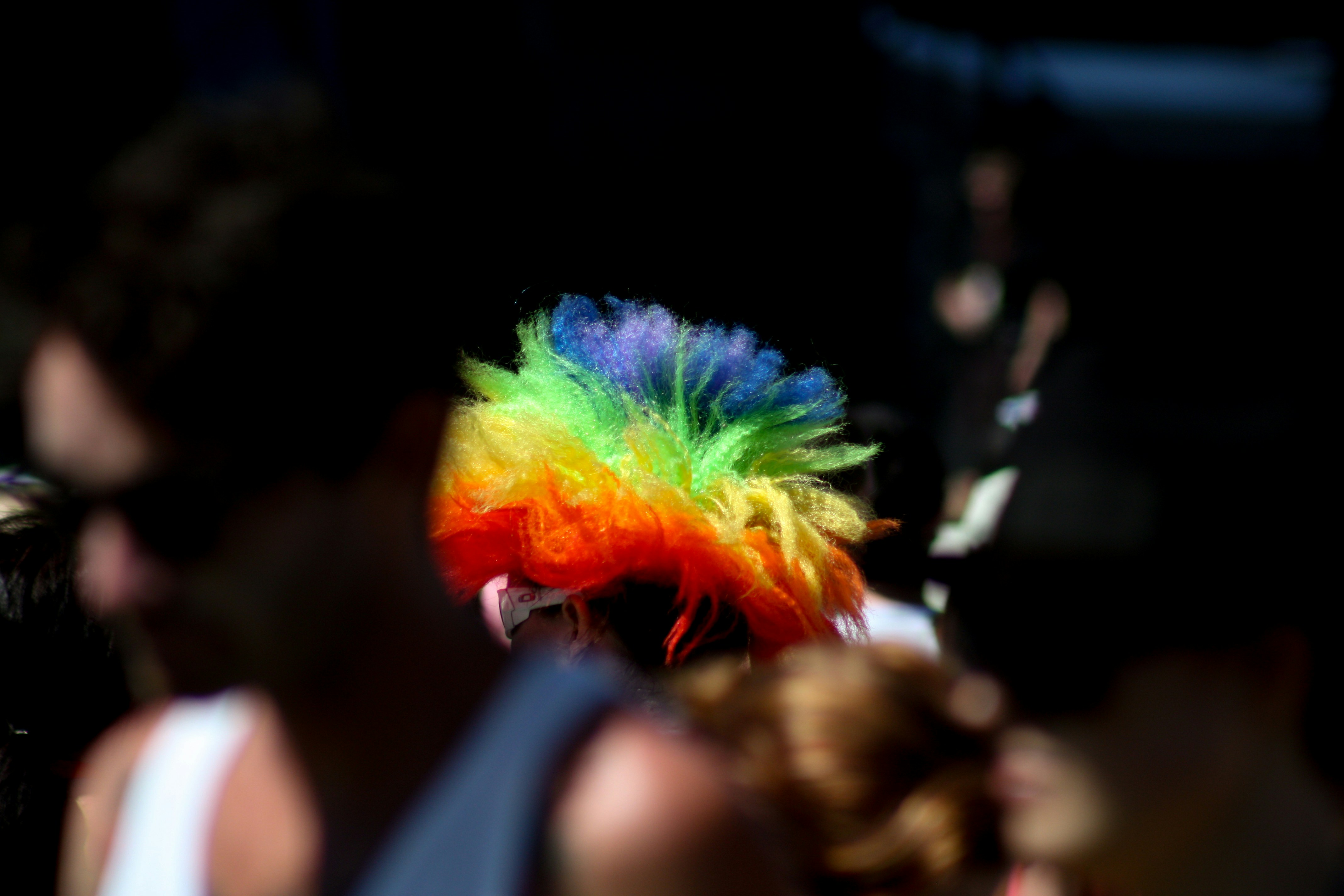 Rainbow Crest Amid Dark Crowd