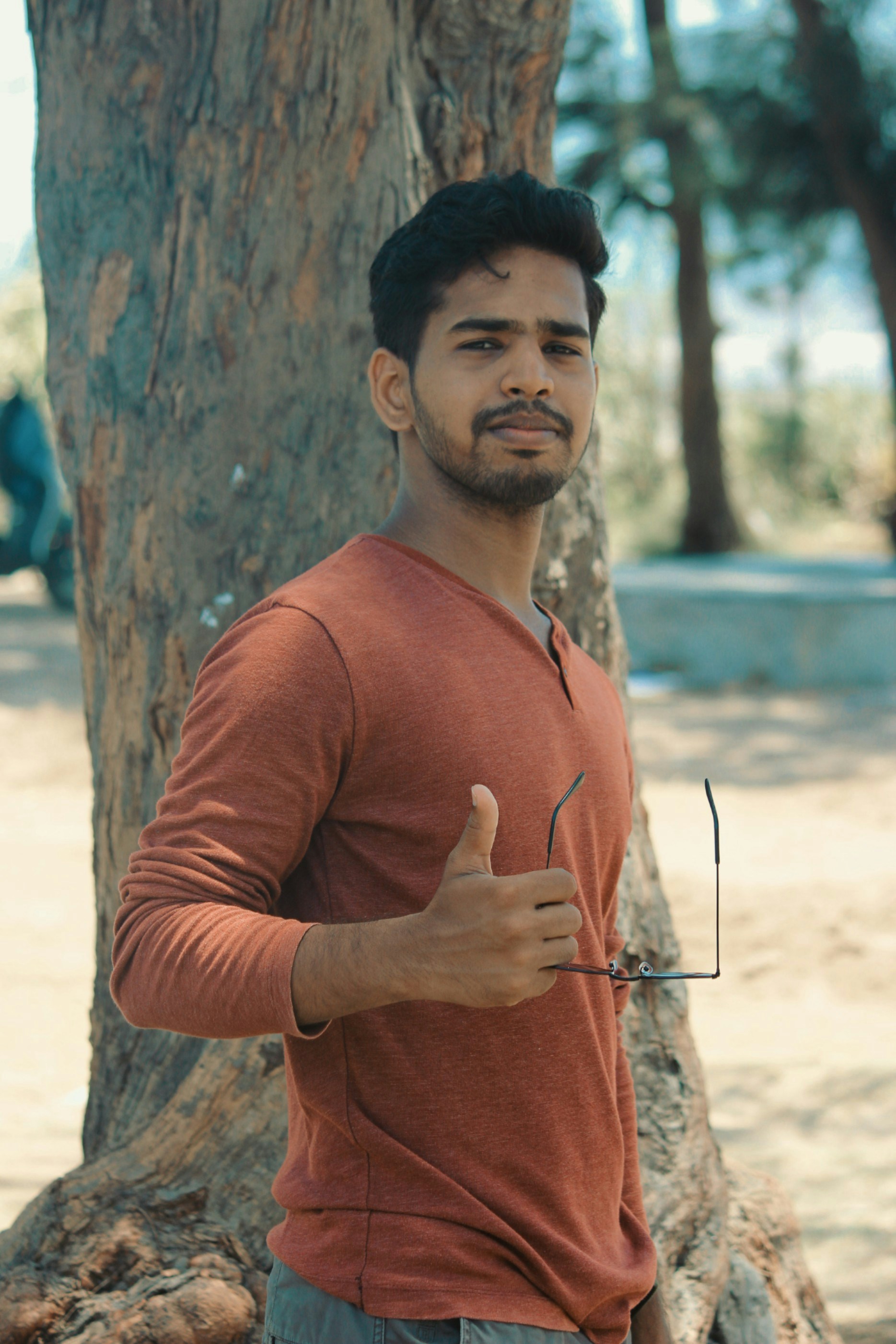 Man standing near tree holding sunglasses photo – Free Mumbai Image on ...