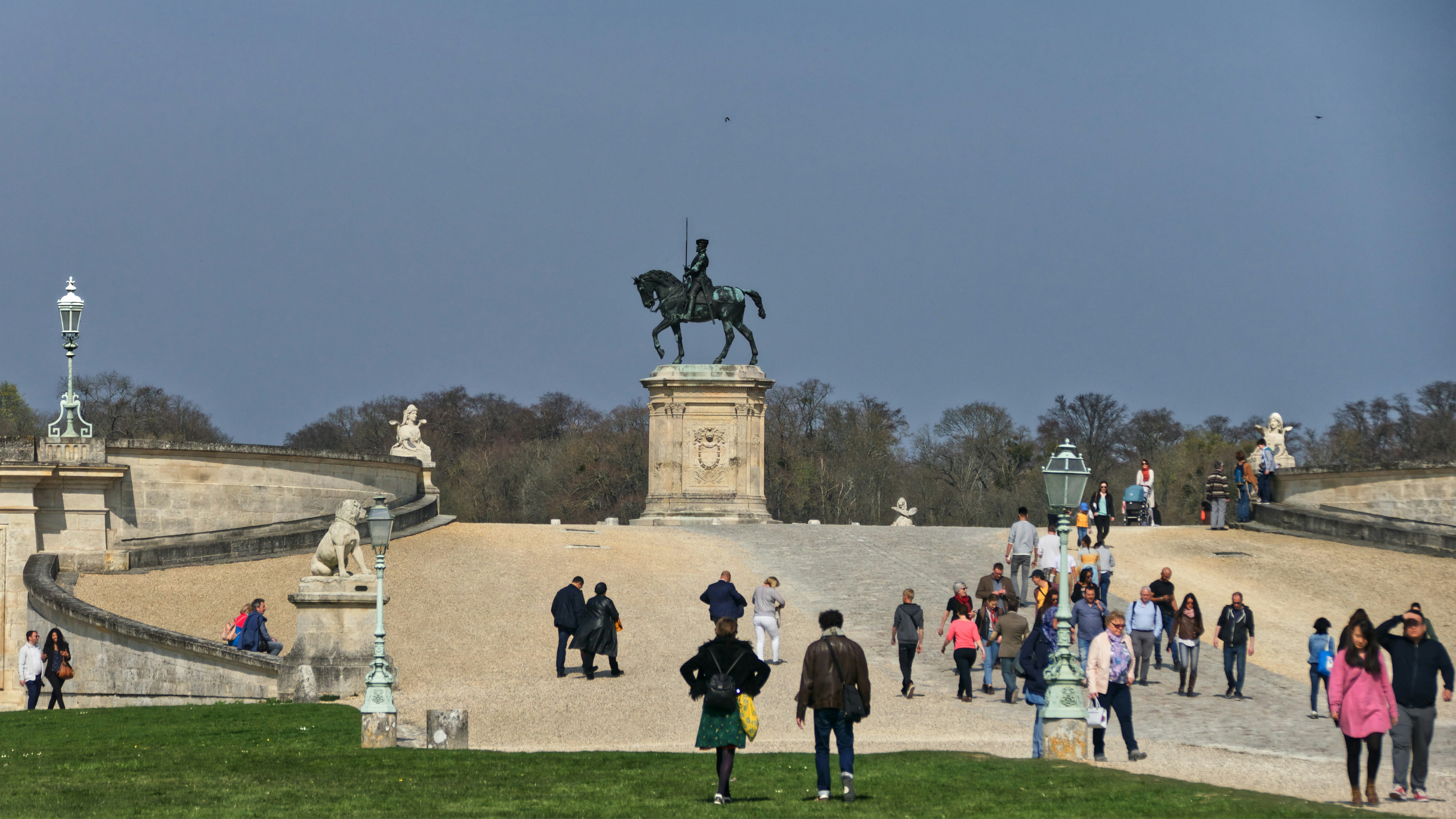 Equestrian Summit: Crowds Gather Beneath a Hilltop Monument