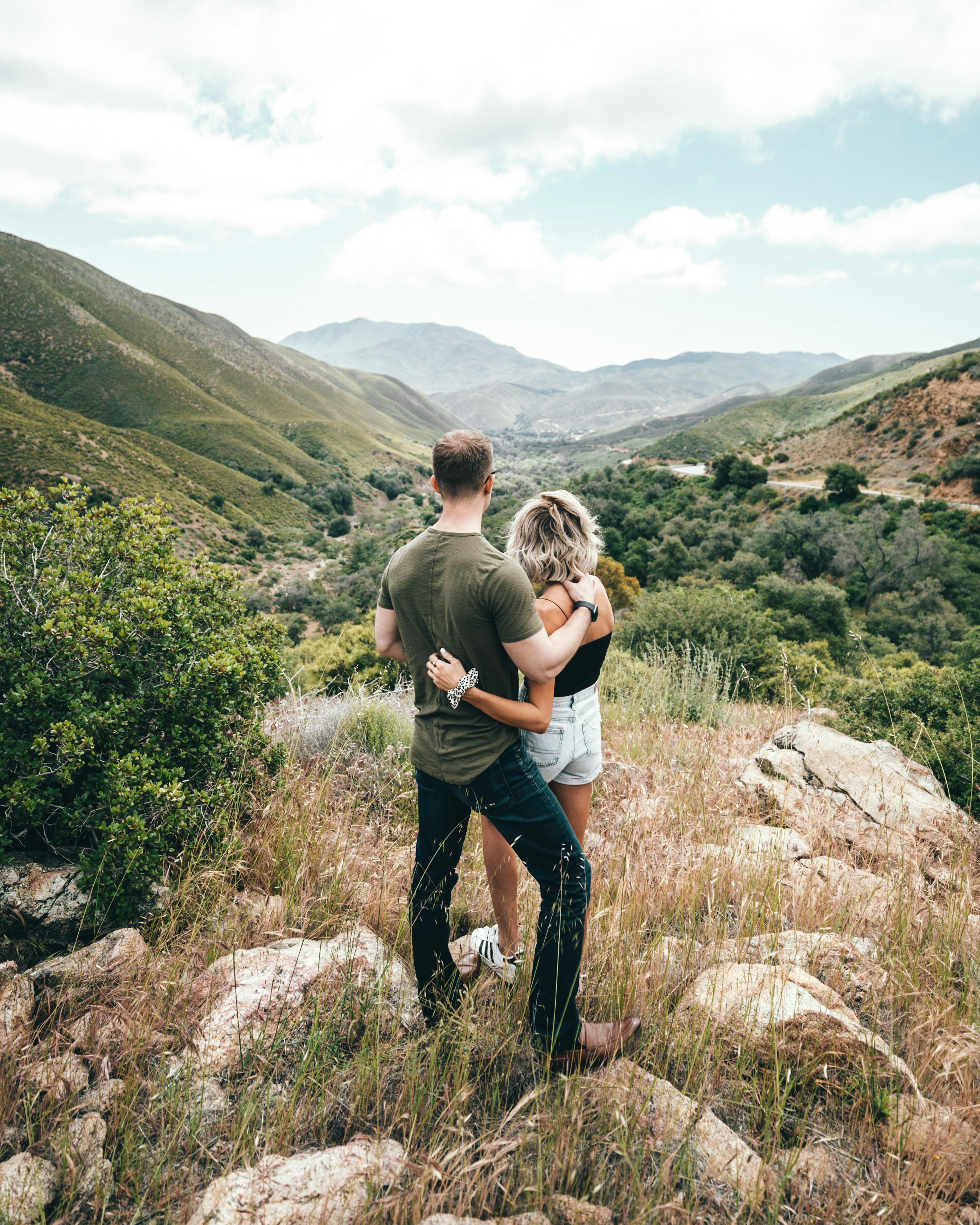 Horizon Embrace: A couple's quiet overlook above a sunlit valley