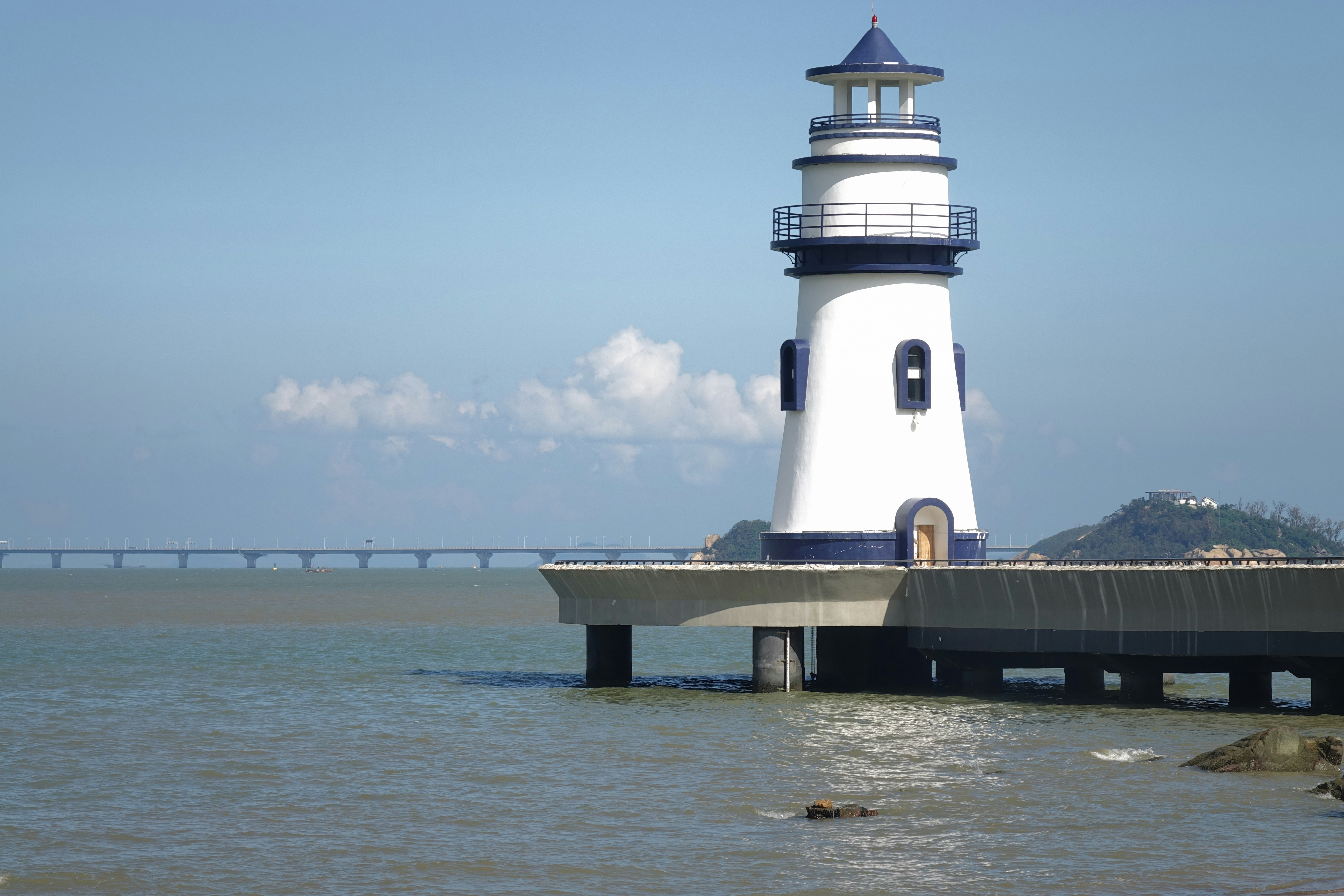 lighthouse on dock during day