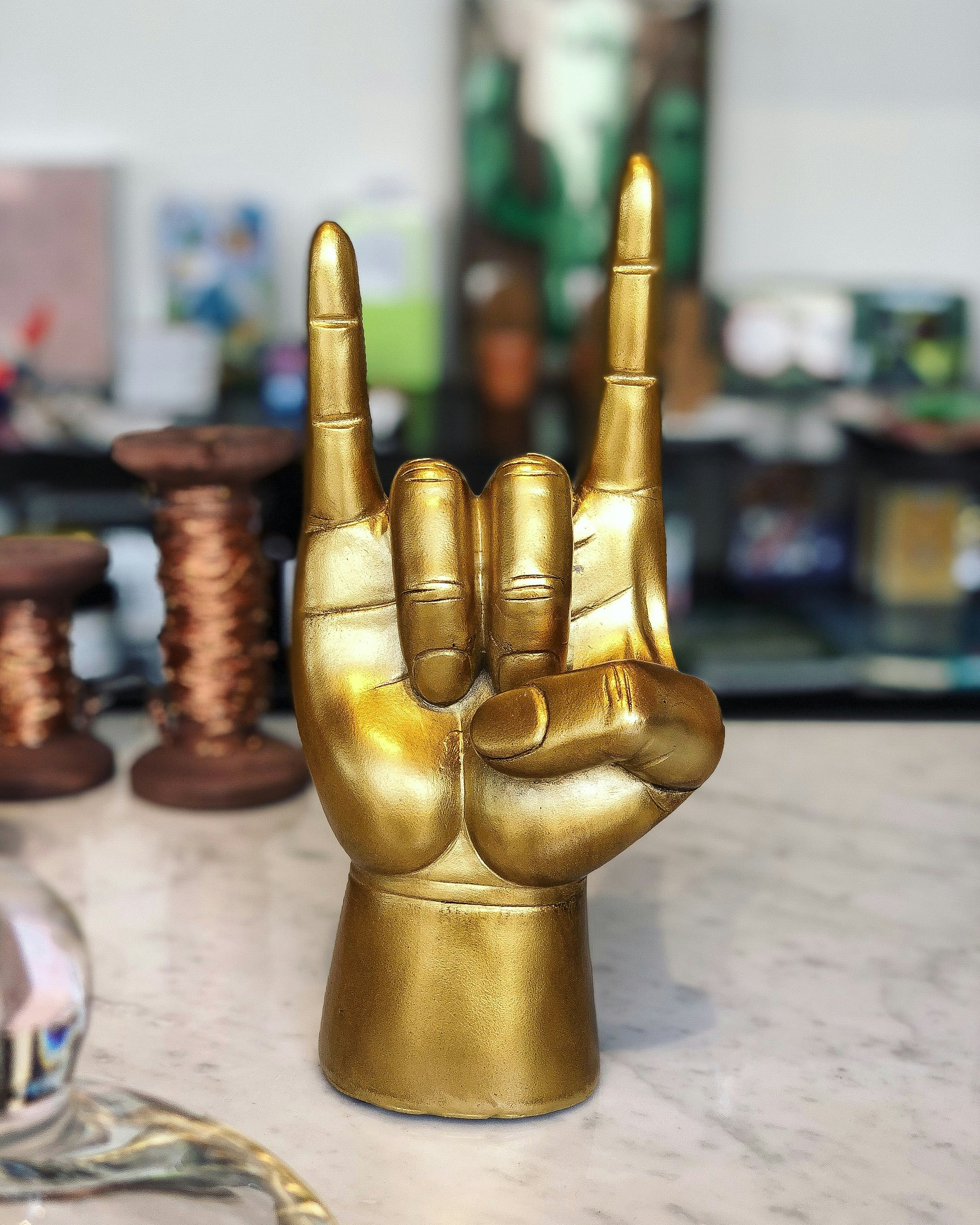 Golden Hand Rocking Out: A Metallic Statue in Focus