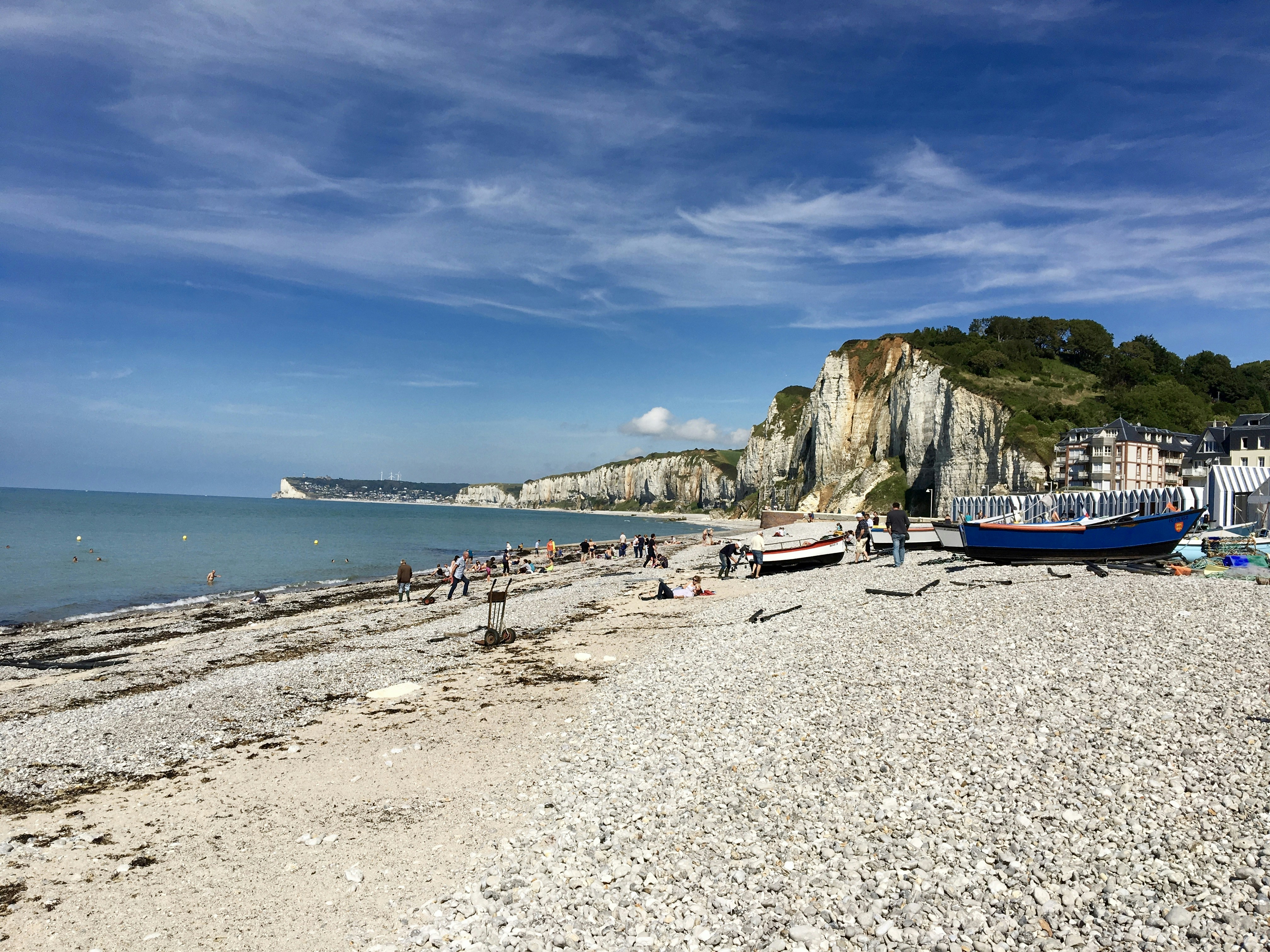 blue boat near ocean