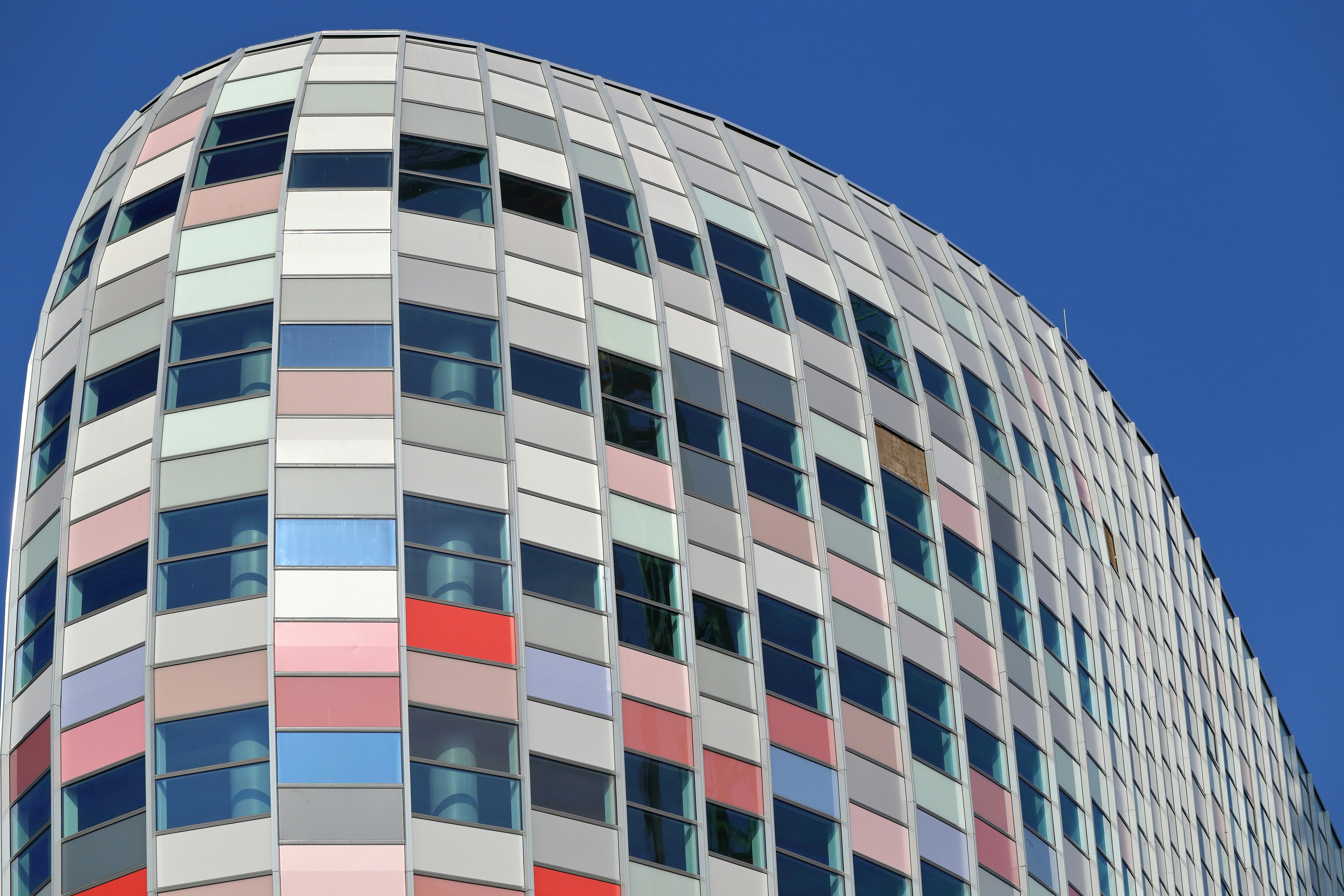 Candy-coated façade: a curved mosaic of pastel panels