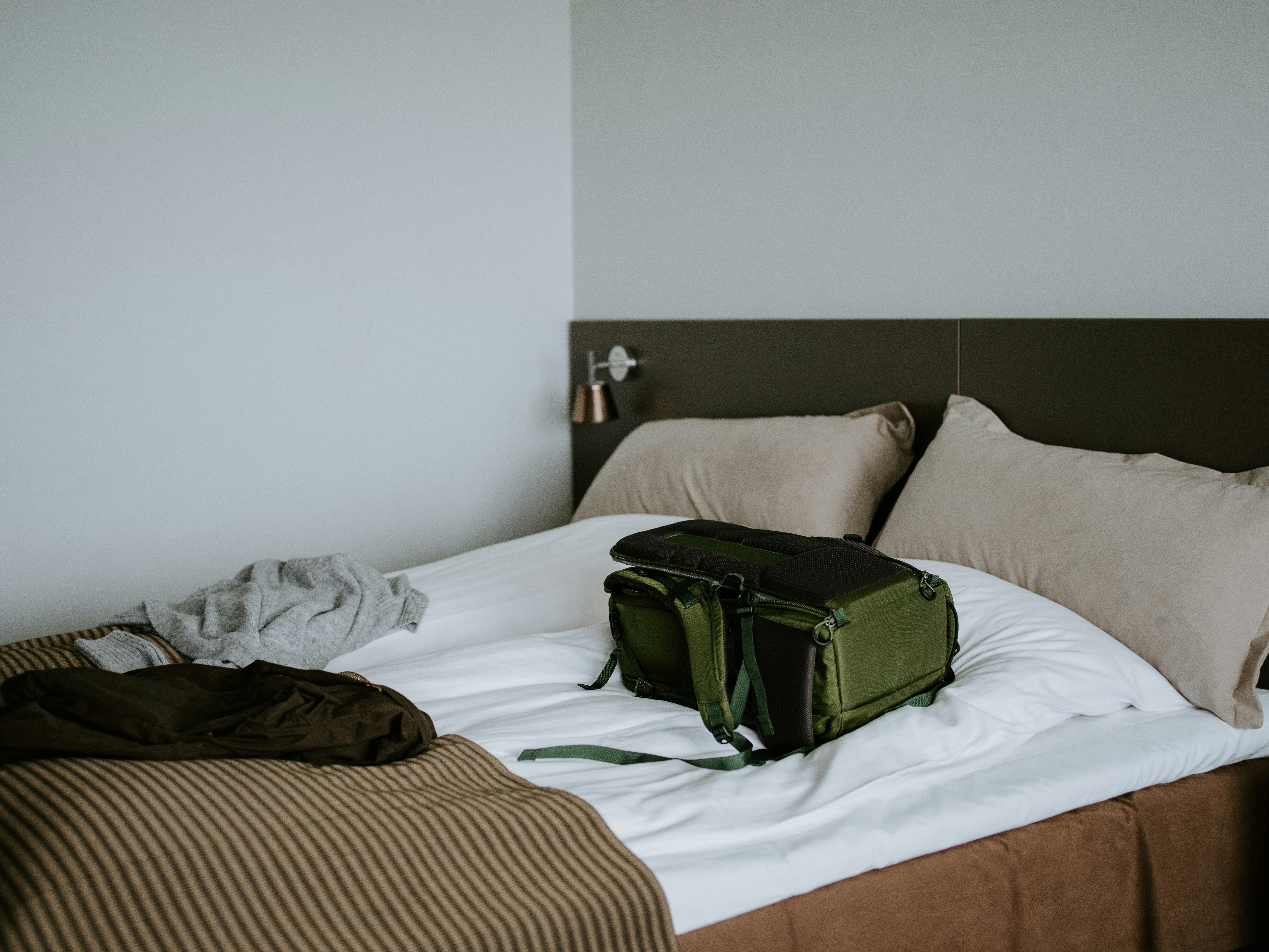 Green backpack on bed photo – Free Grey Image on Unsplash