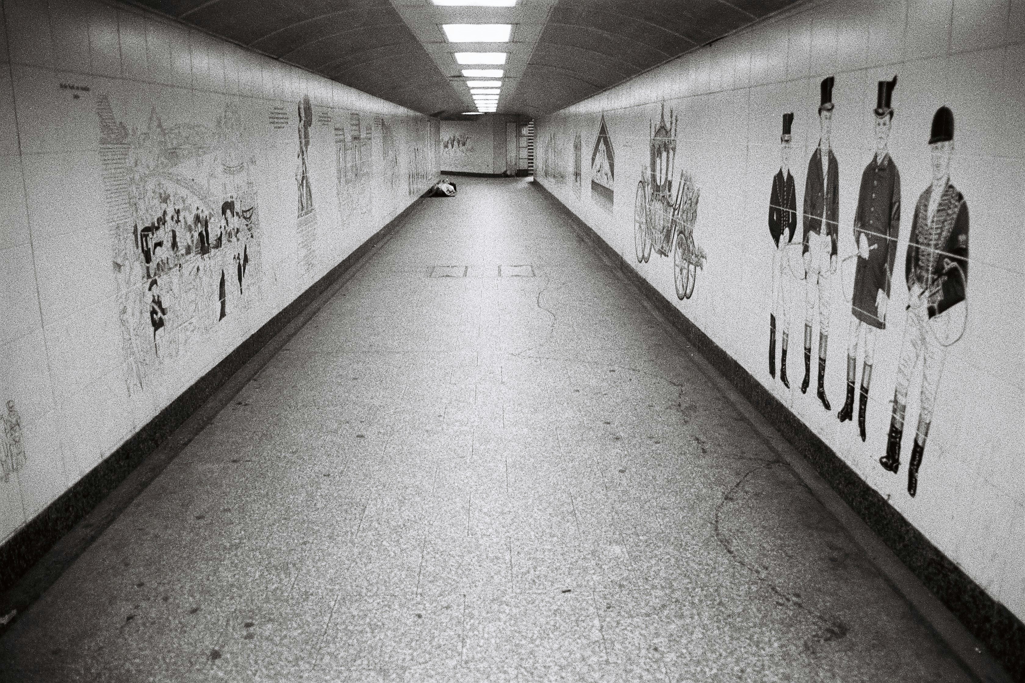 Vanishing Corridor: Murals Stretch into a Quiet Subway Tunnel