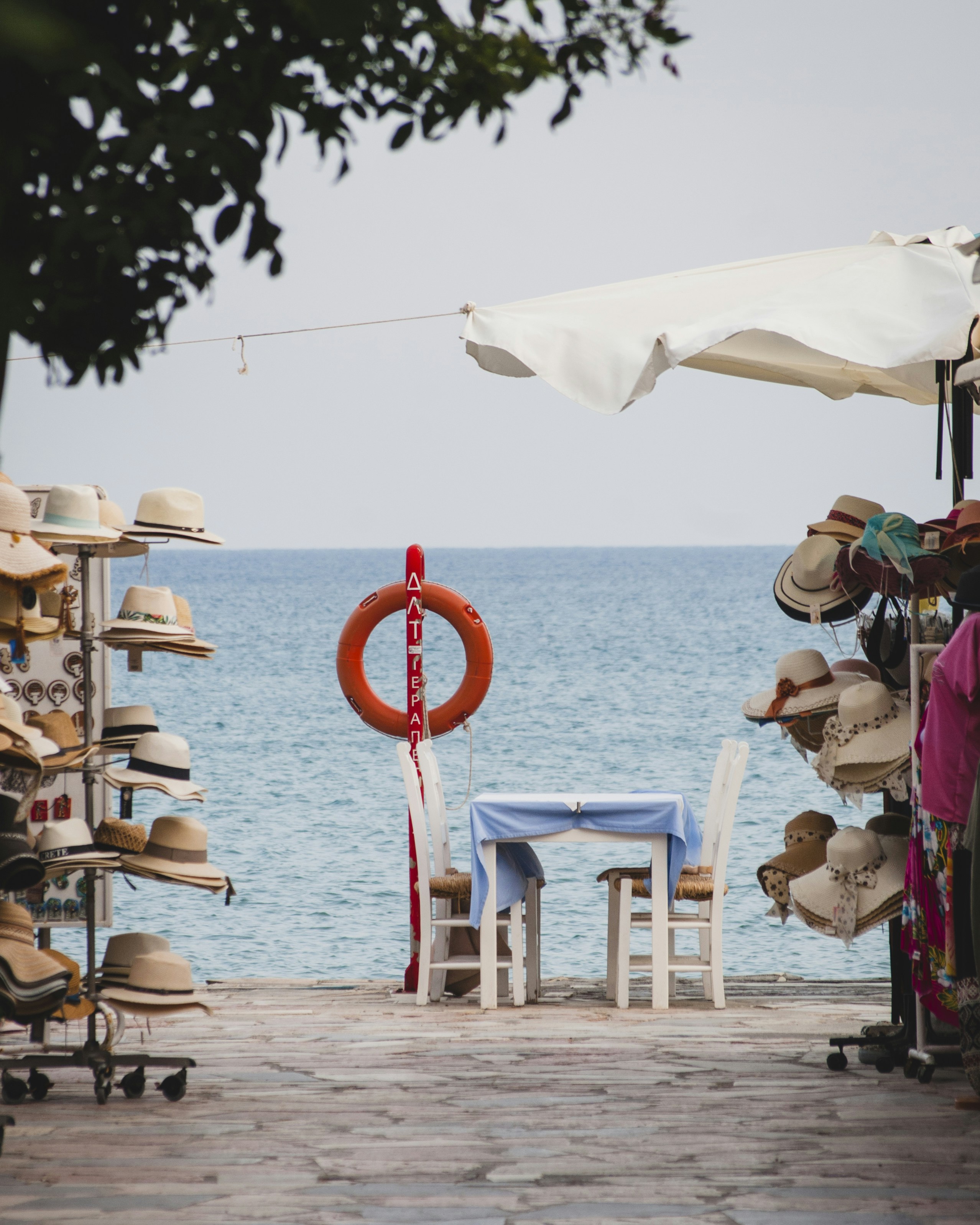 Lifebuoy Between Hat Aisles at a Seaside Market
