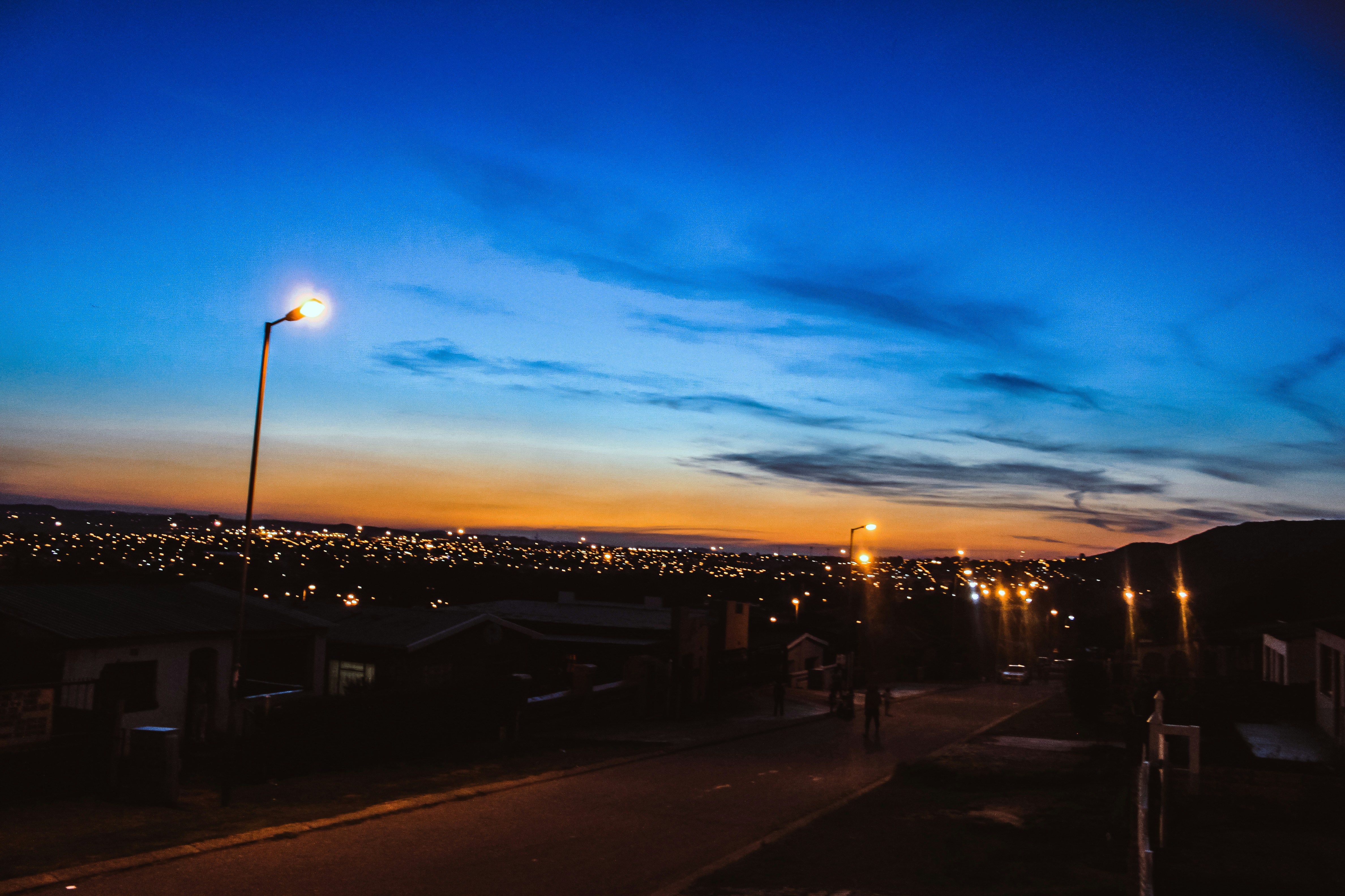 light posts turned-on on streets during nighttime