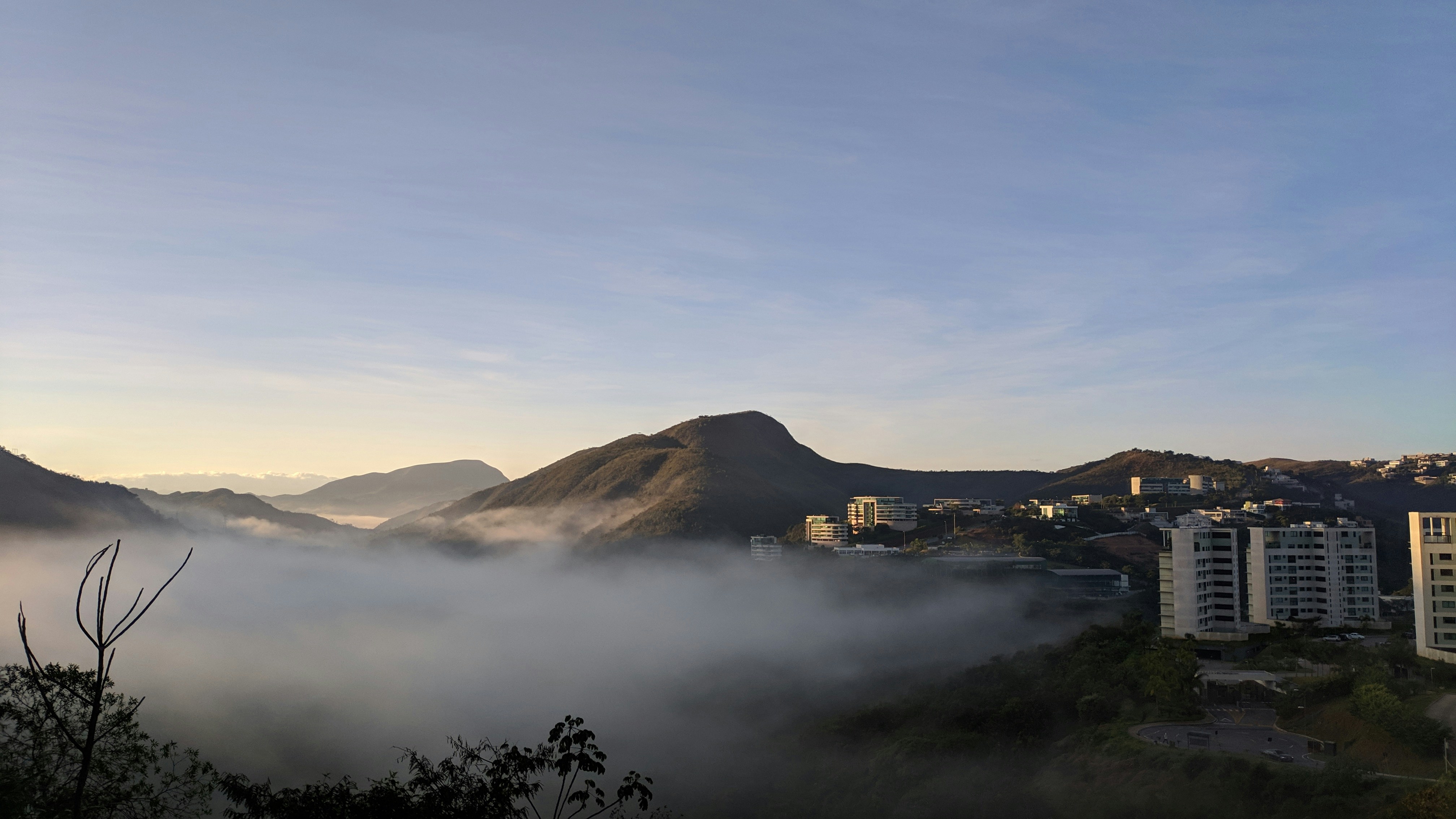 Mist Over the Valley: Dawn Lights Between Hills and City