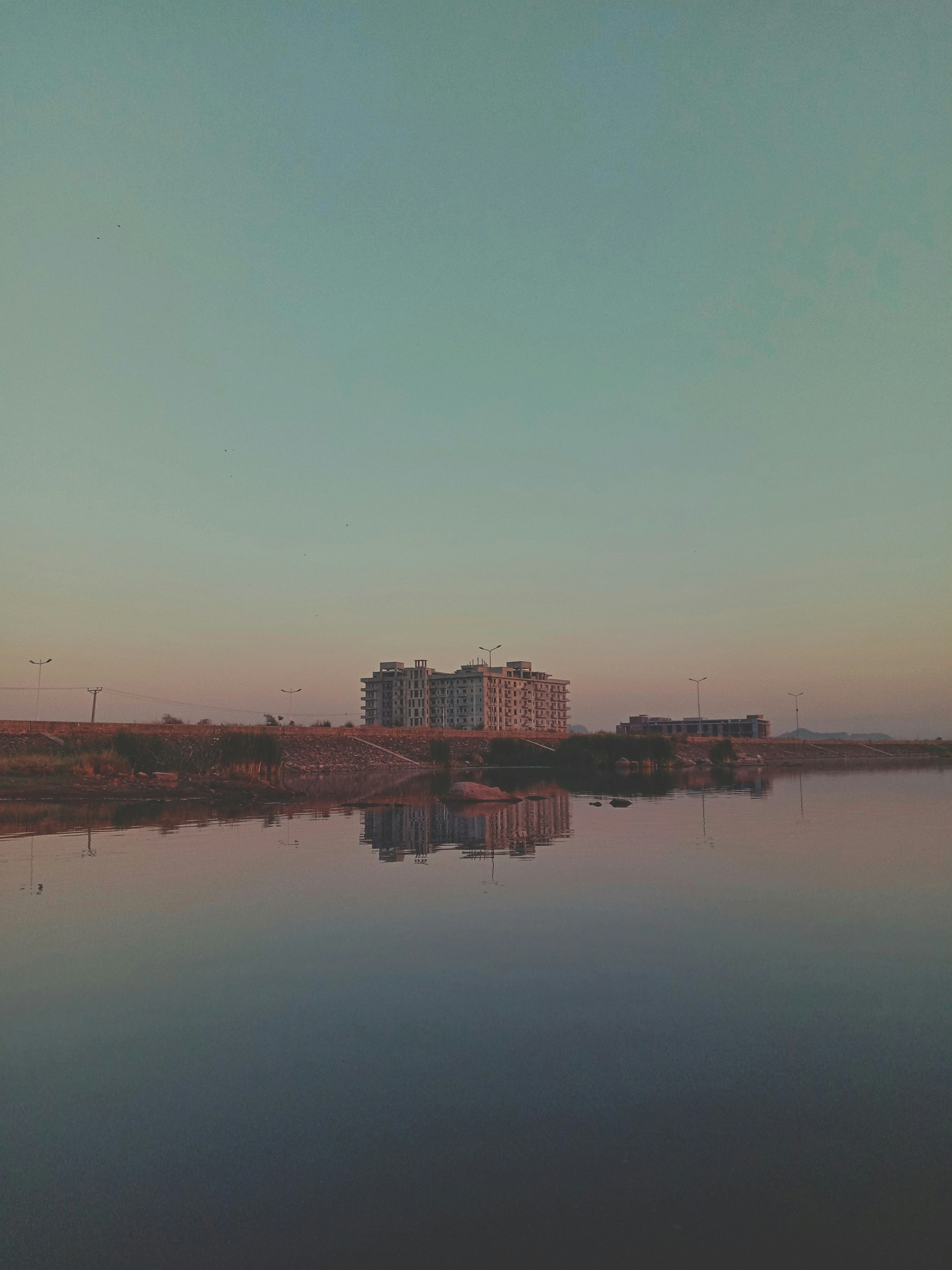 Landscape photography of building near body of water during daytime ...