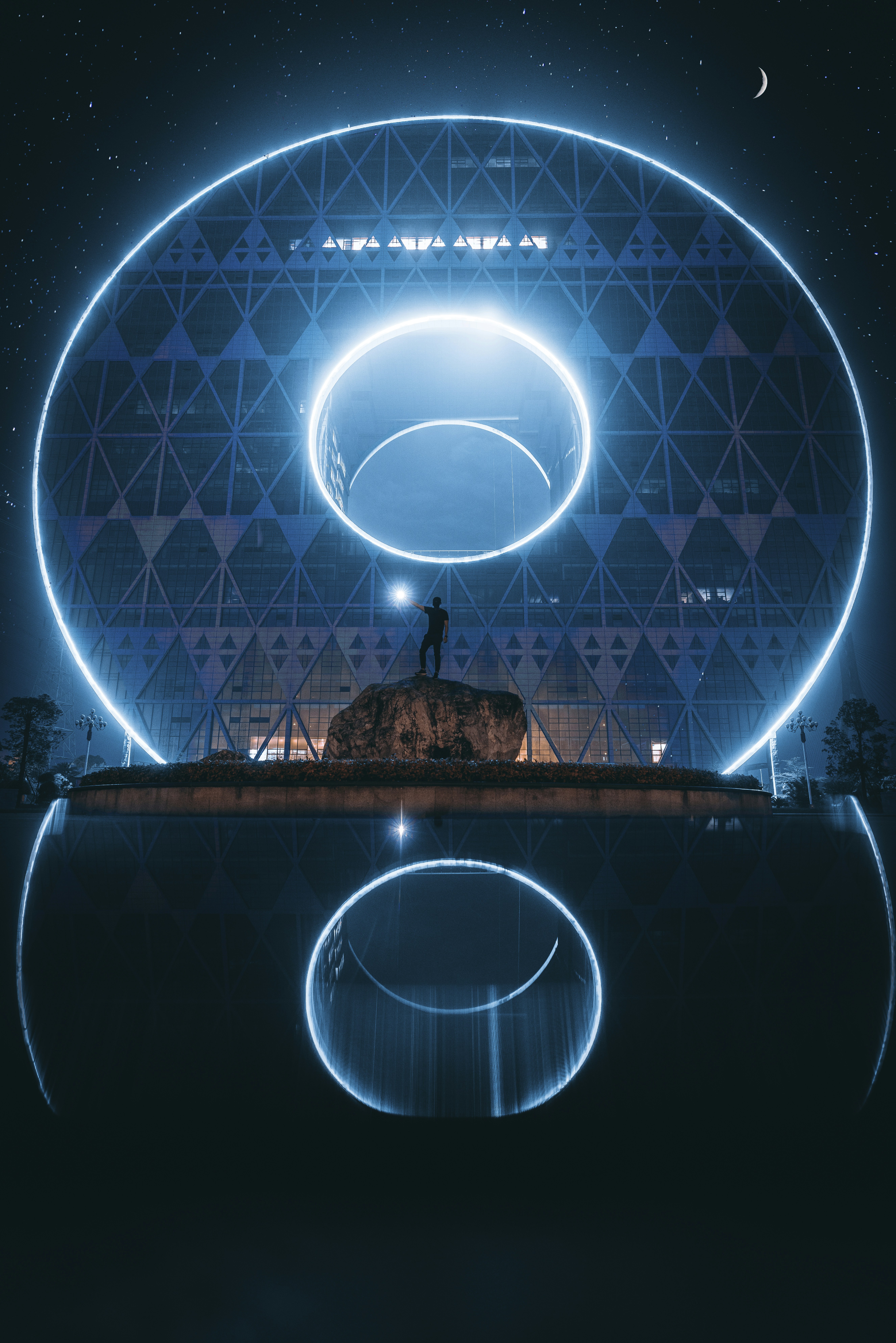 Circle of Light: A Silhouette Beneath Neon Orbits