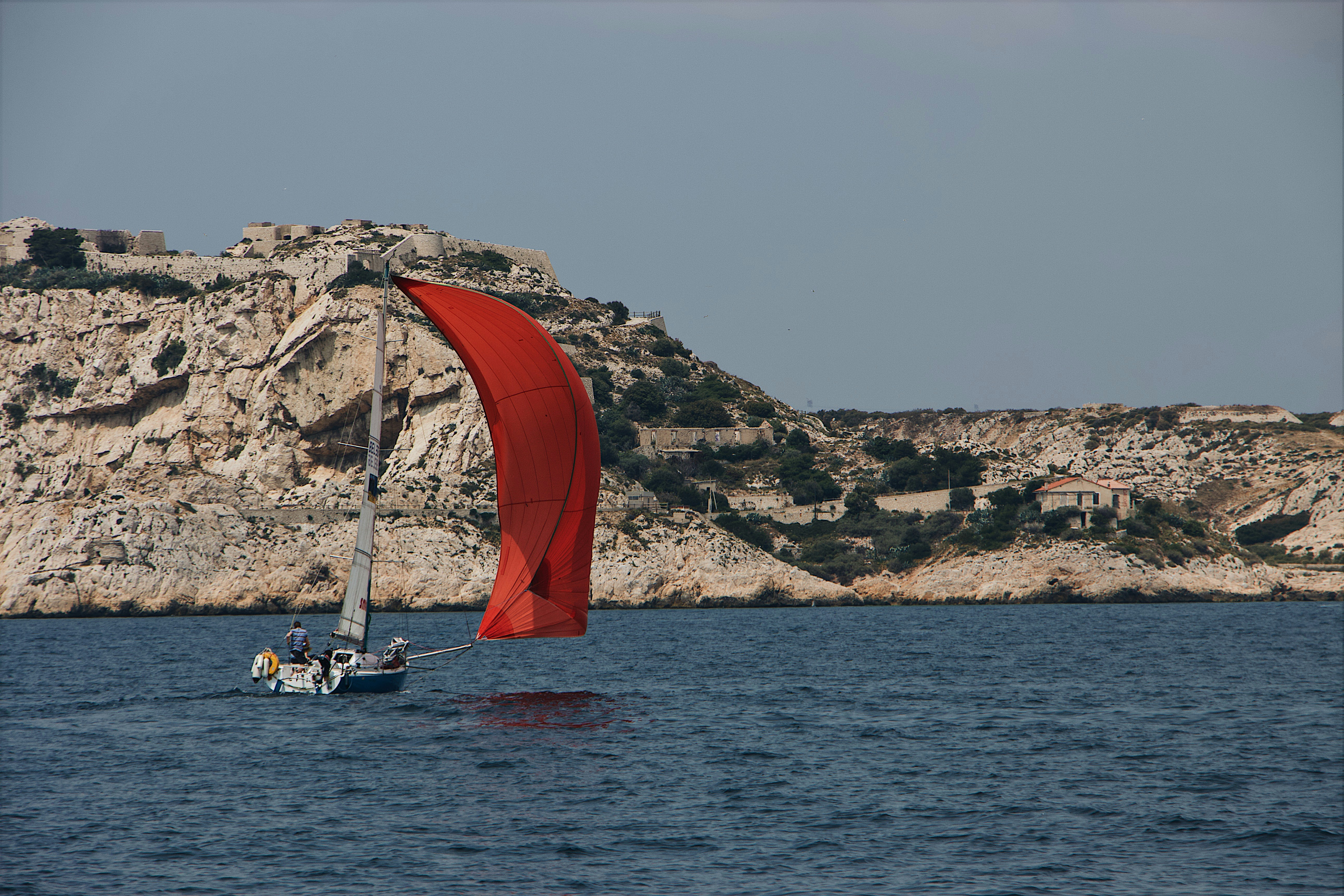 Crimson Sail on Serene Waters