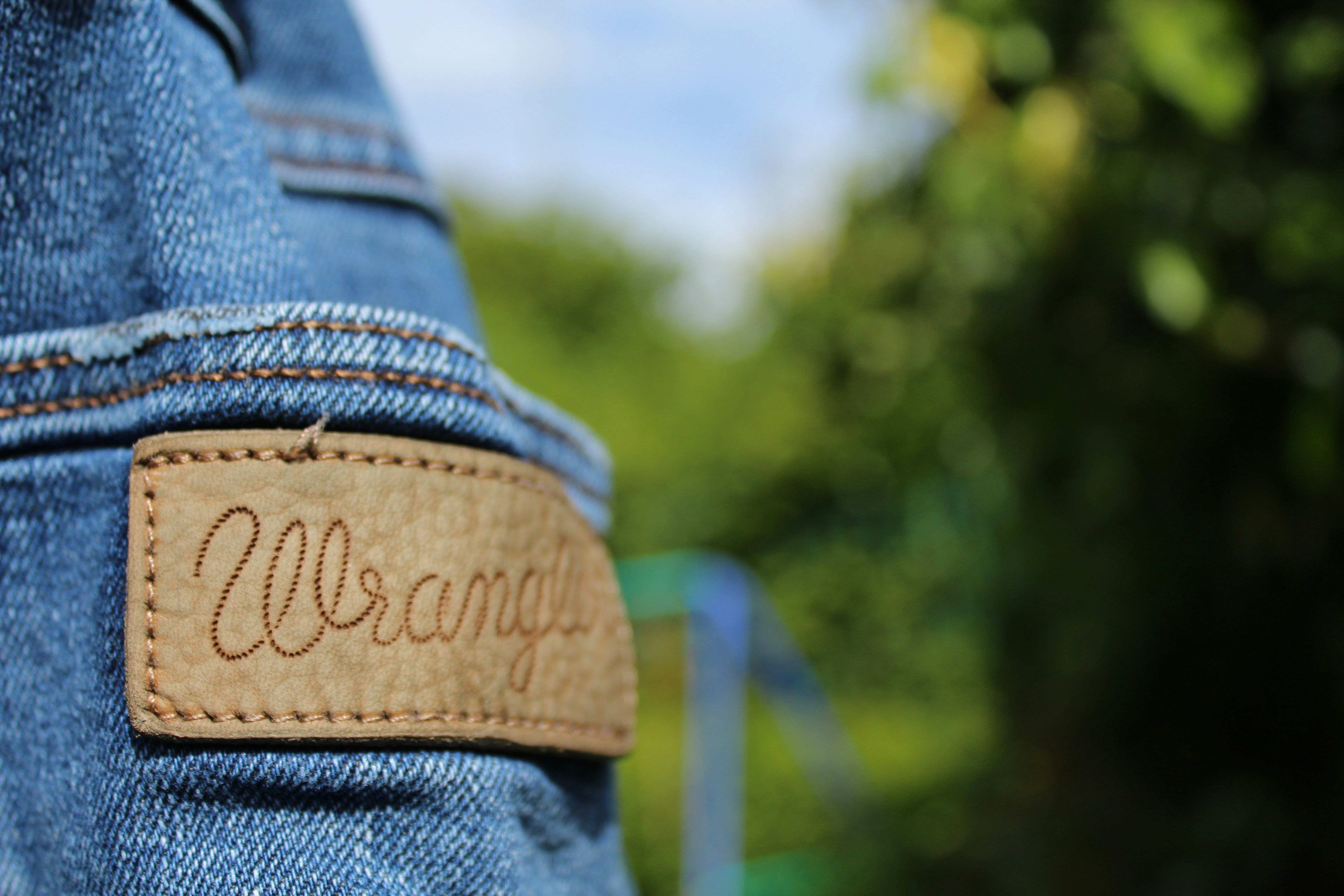 Wrangler Patch in Quiet Focus: Denim Texture with a Green Backdrop
