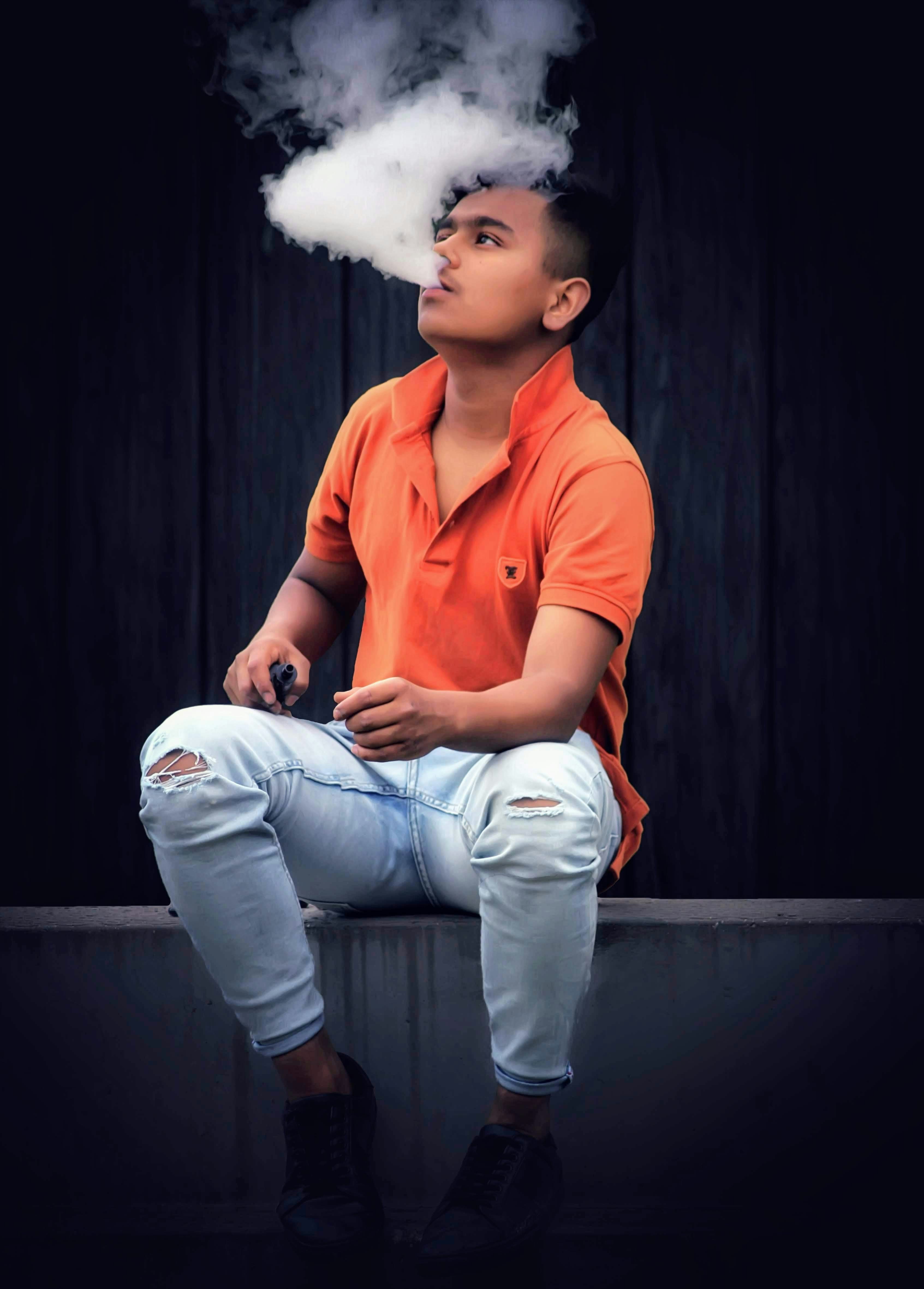 man sitting while smoking