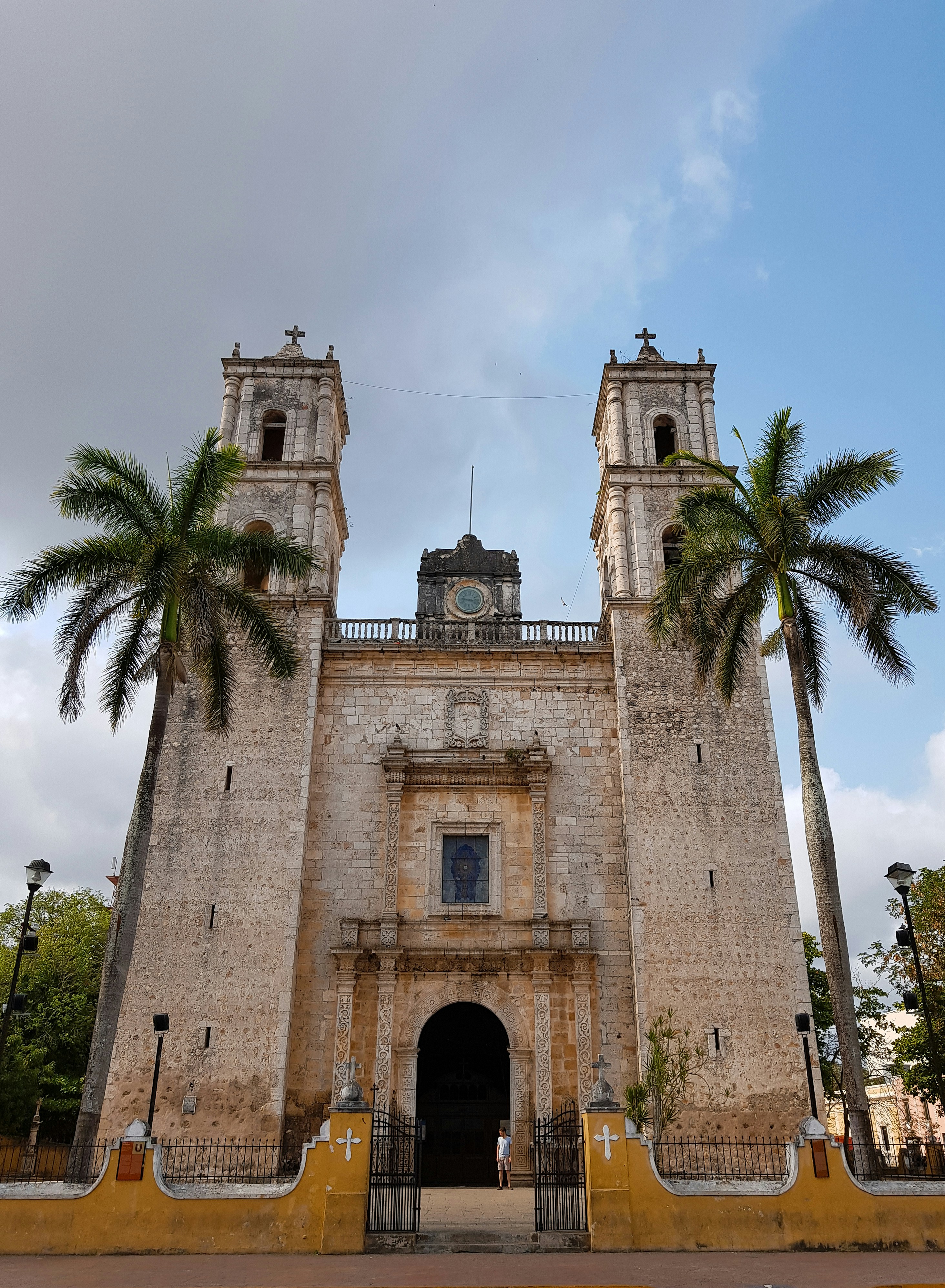 Symmetrical Cathedral Portal Framed by Palms on a Bright Day