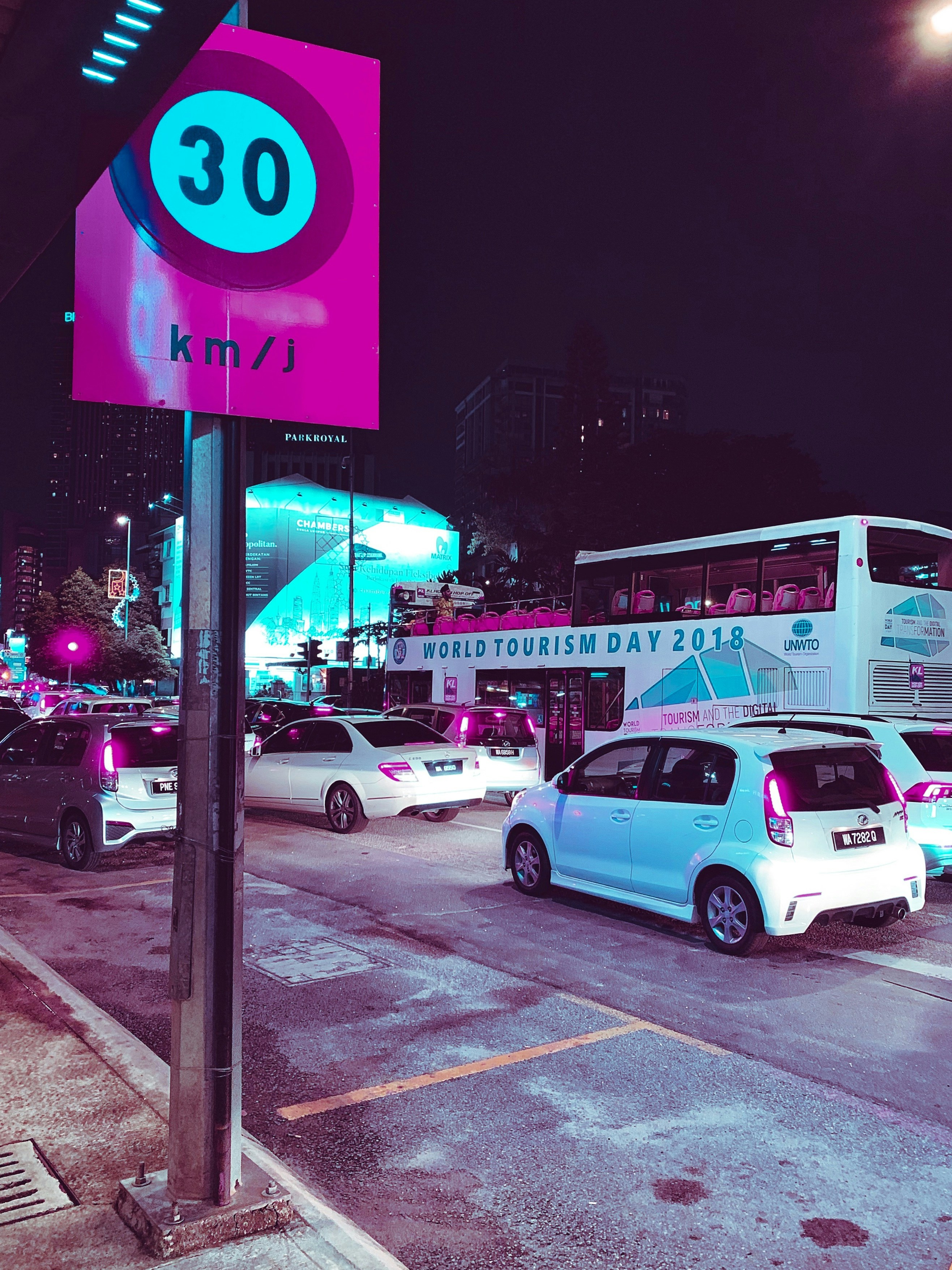Neon Crossroads at Night: World Tourism Day 2018 Bus Parade