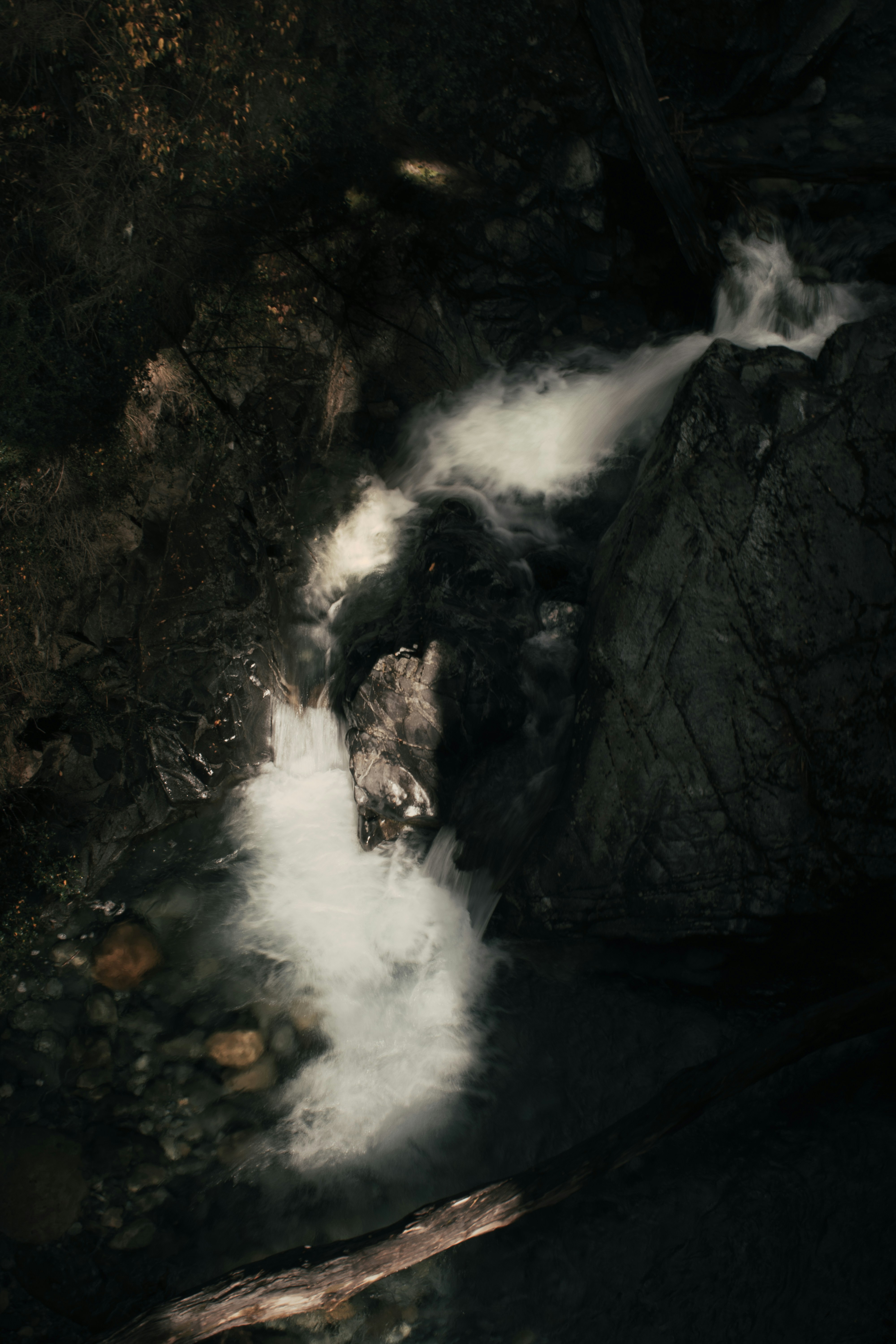 A stream of water running down a rocky hillside photo – Free Grey Image ...