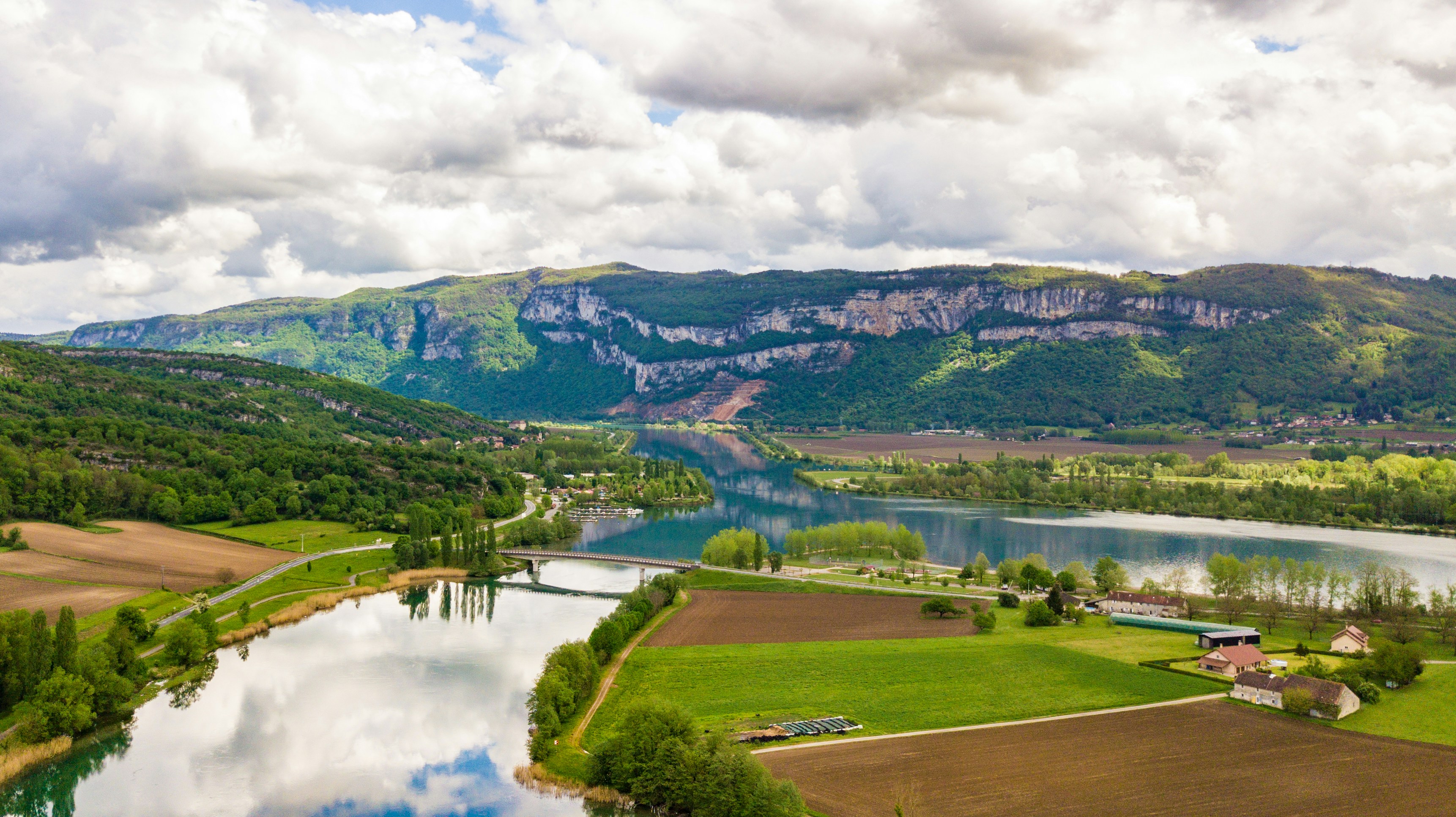 Body of water between green grass field during daytime photo – Free ...