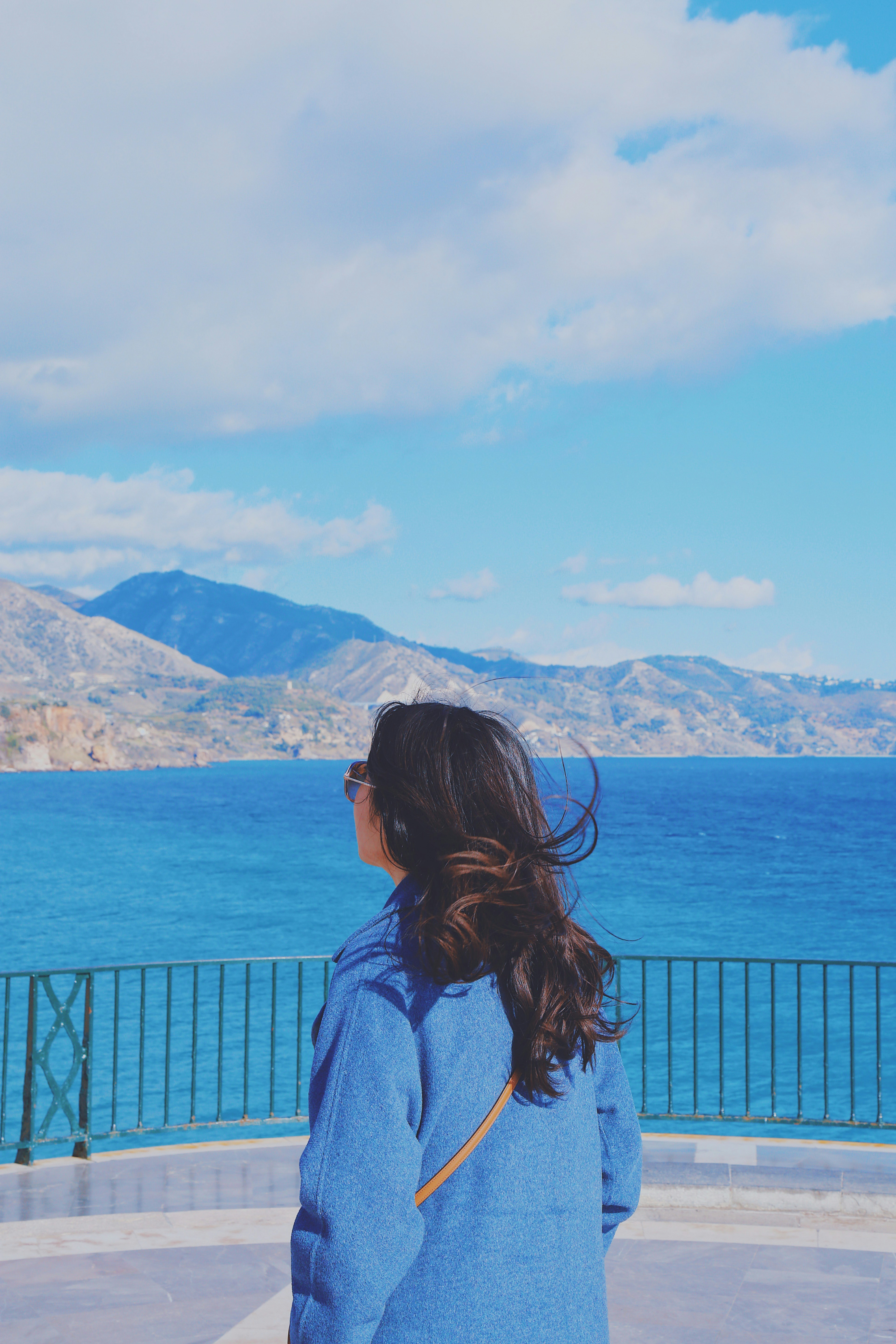 Azure Promenade Reverie: A Woman in Blue Gazes at the Sea
