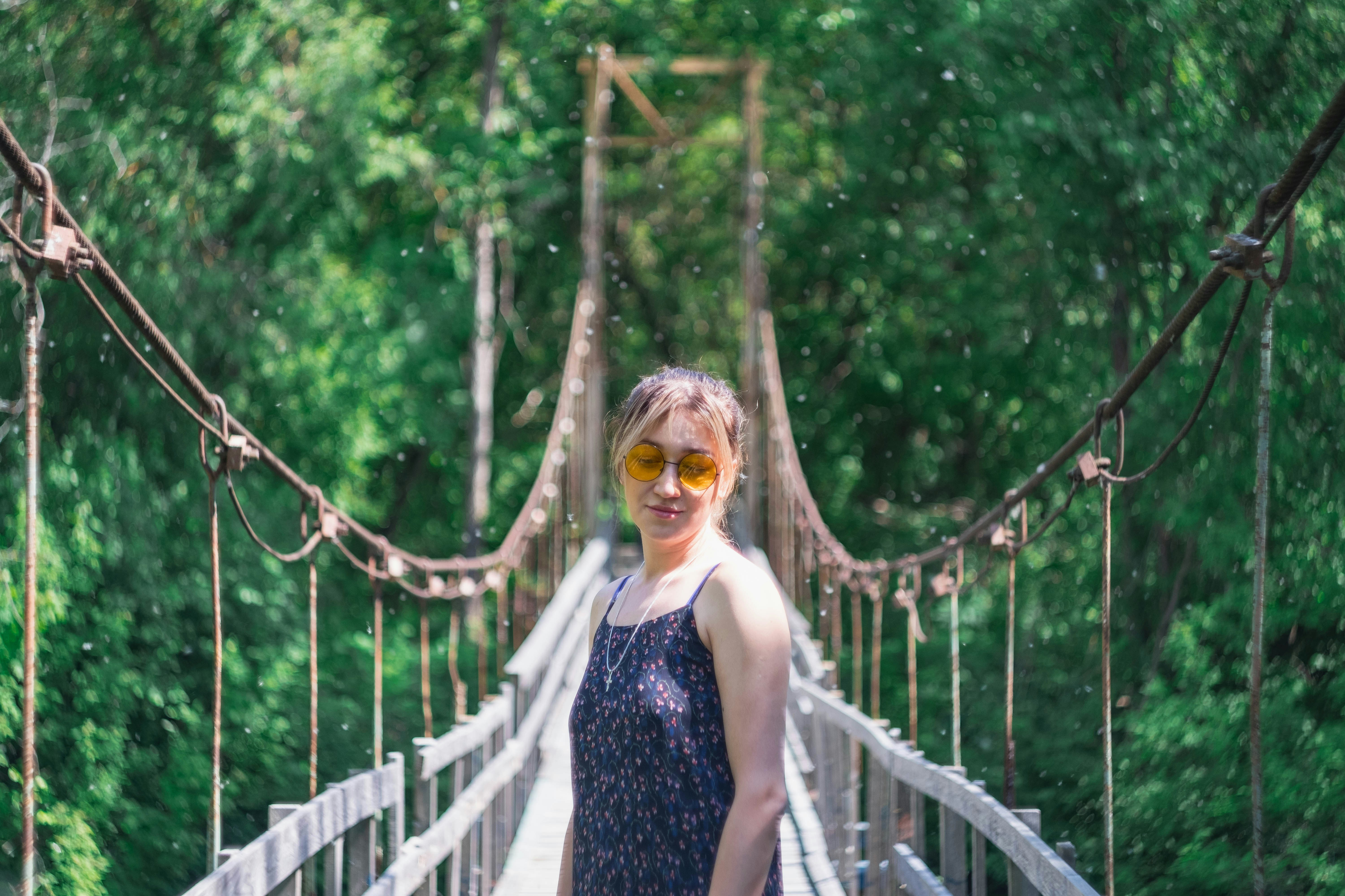 Quiet Portrait on a Green Corridor Suspension Bridge