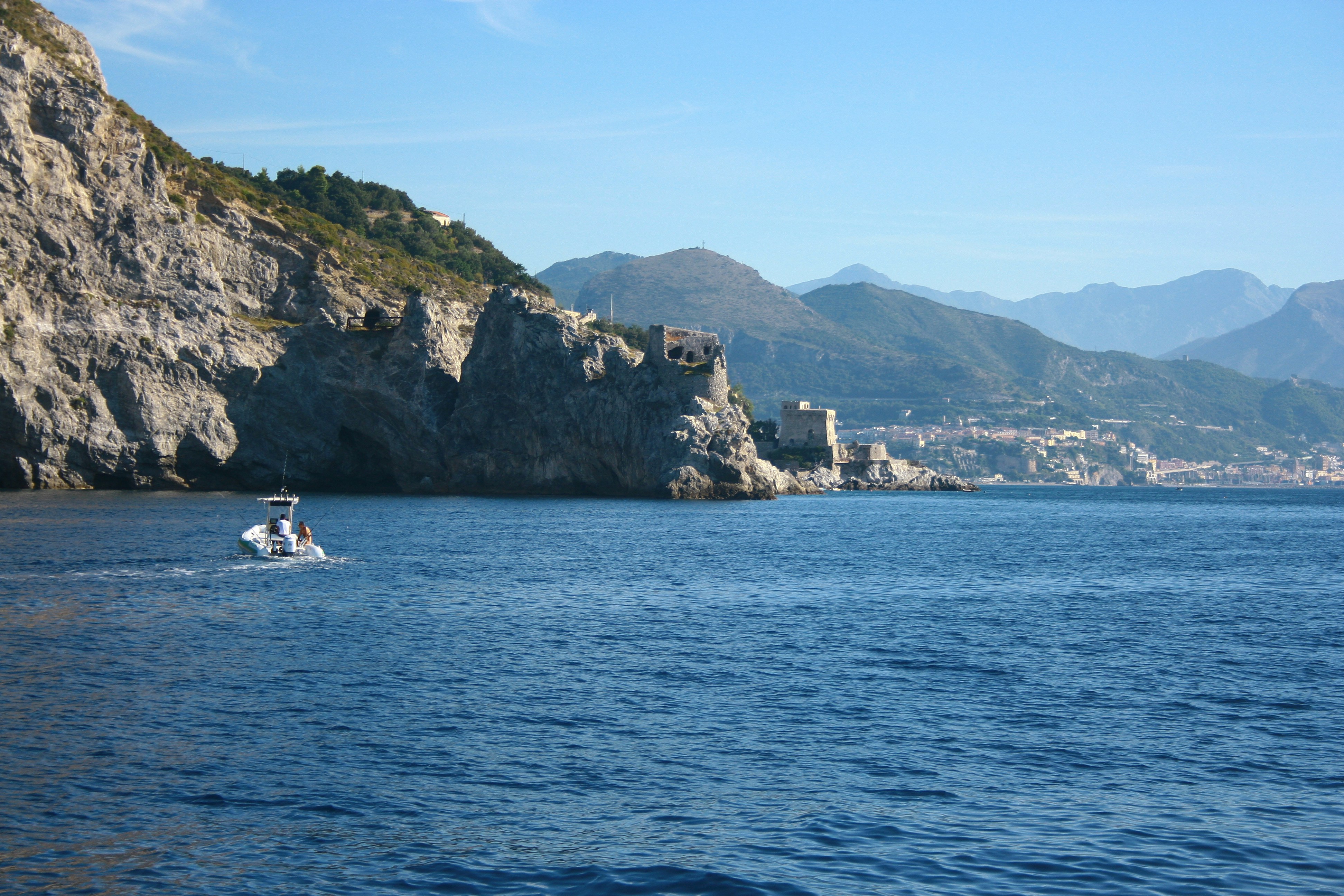 white boat near mountain