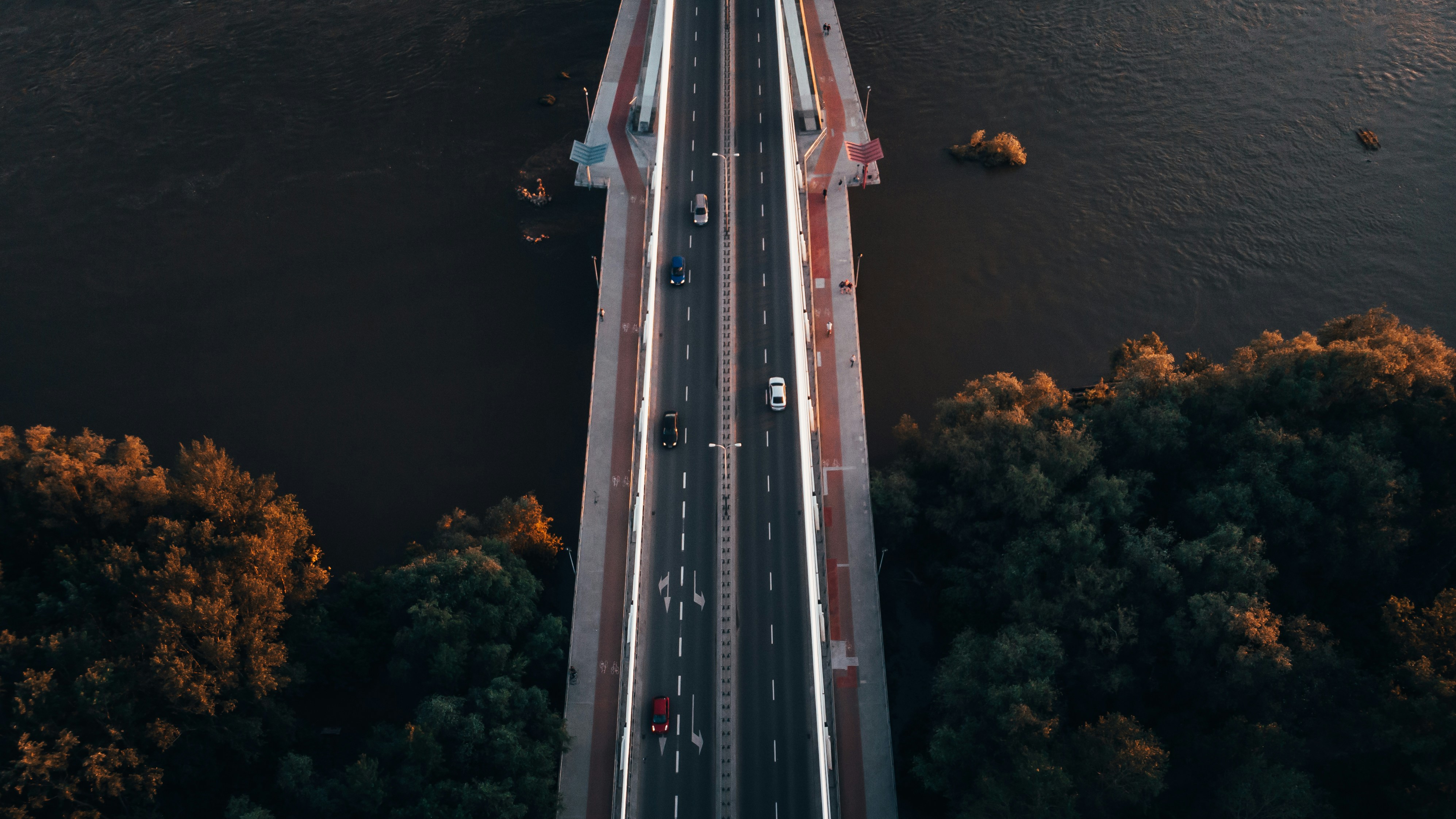 Centerline in Motion: Aerial Snapshot of a River Bridge at Dusk