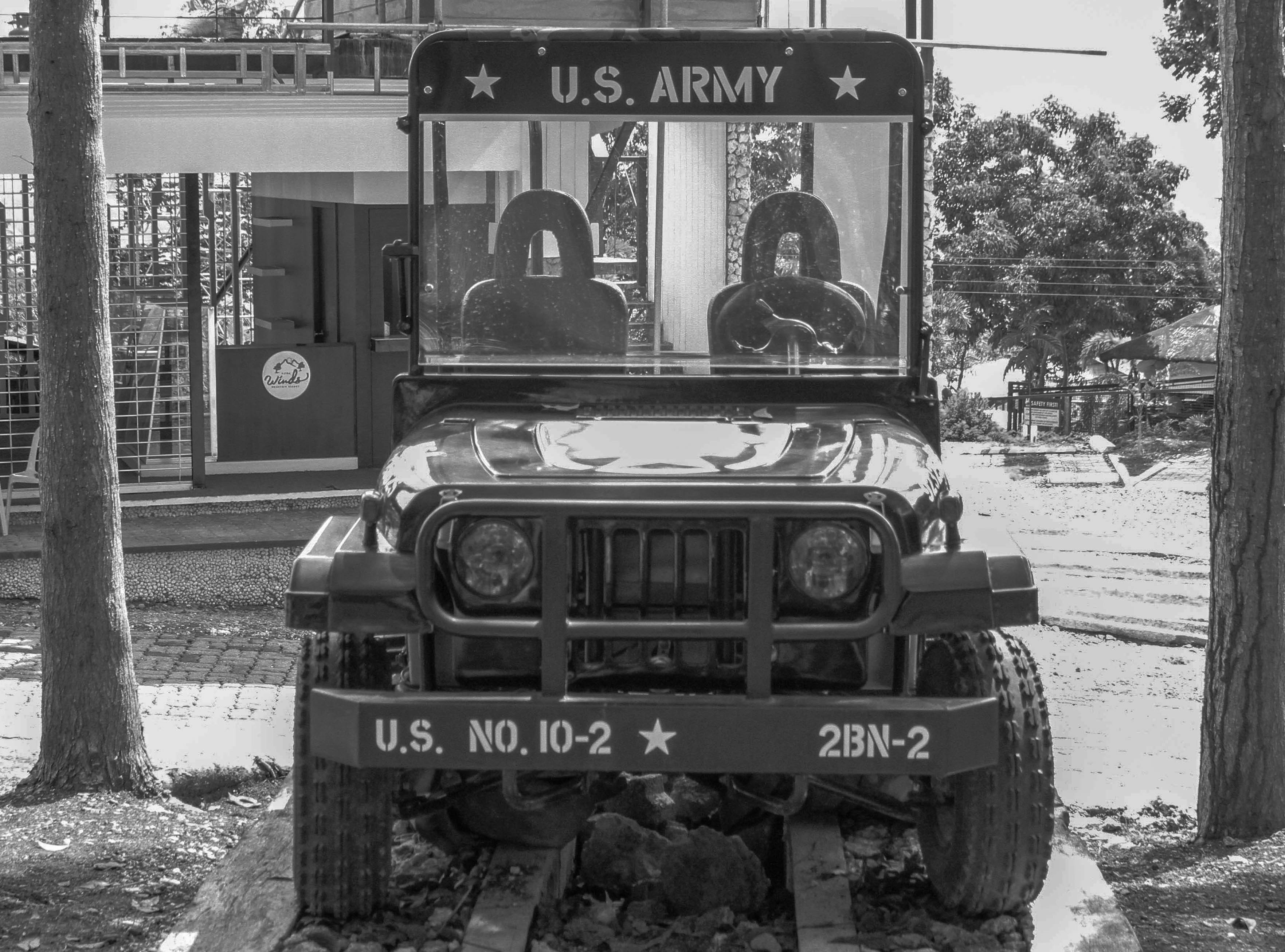 U.S. Army jeep positioned on a track, showcasing its historical significance and rugged design.