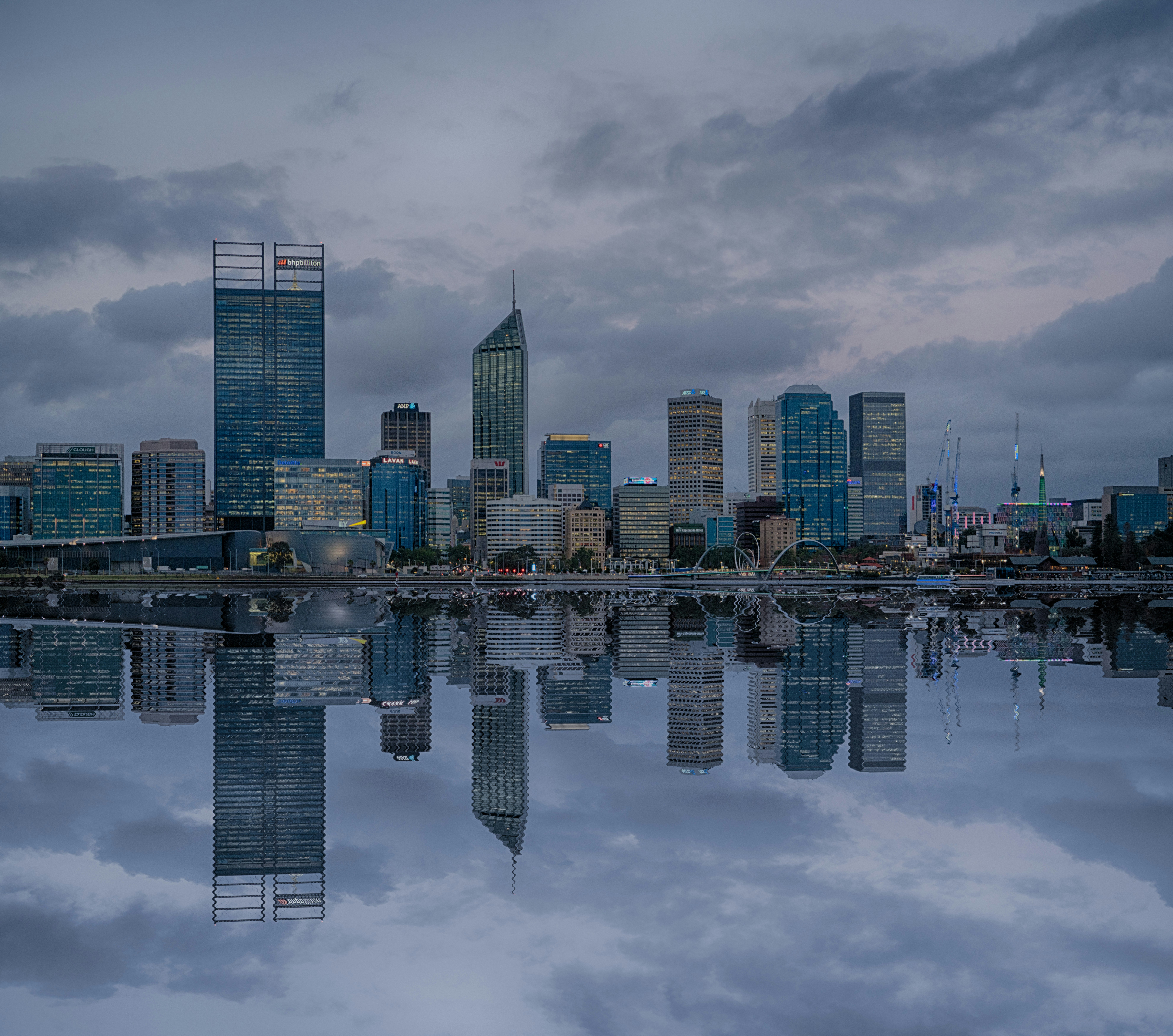 Glassy Horizon: Dusk Skyline Reflected on a Quiet Harbor