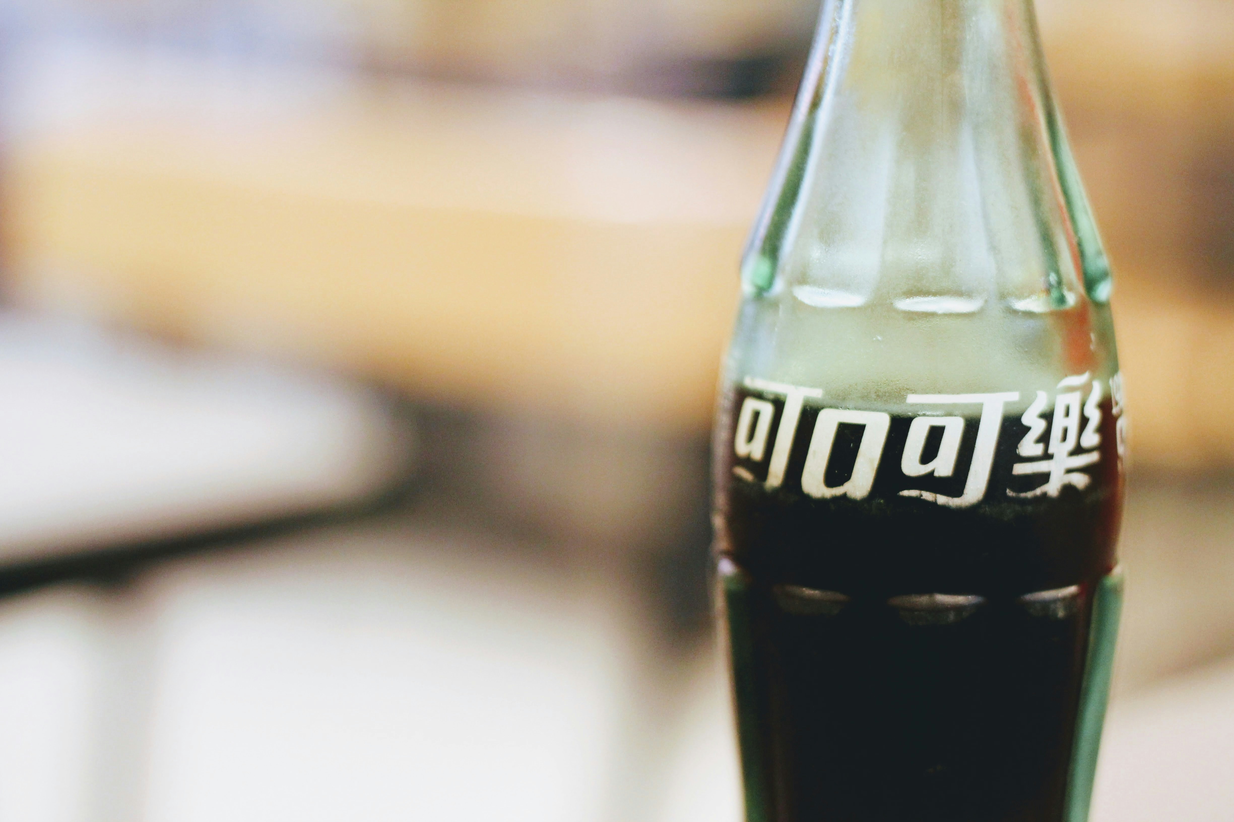 Whispered Script on a Narrow Soda Bottle