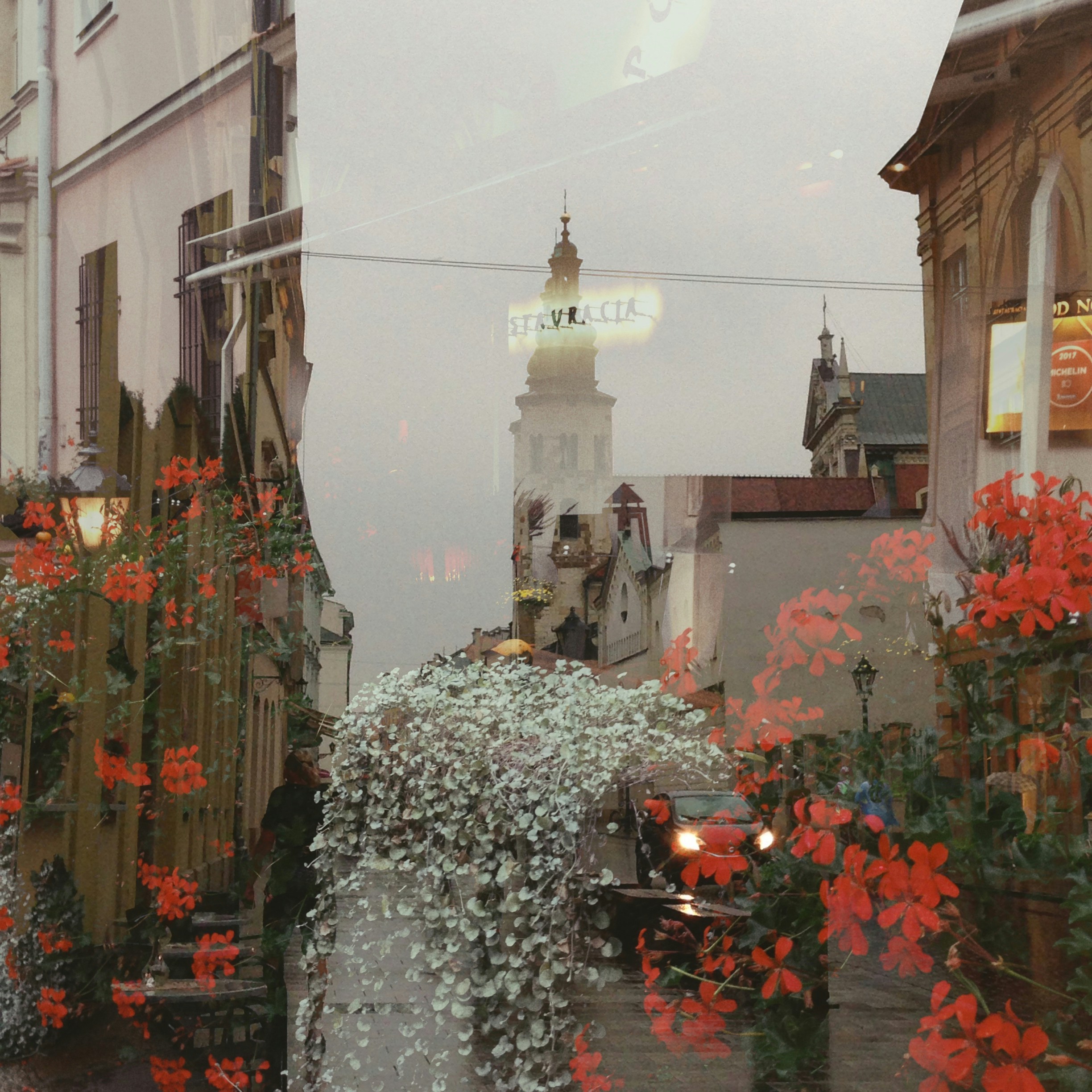 a city street with a clock tower in the background