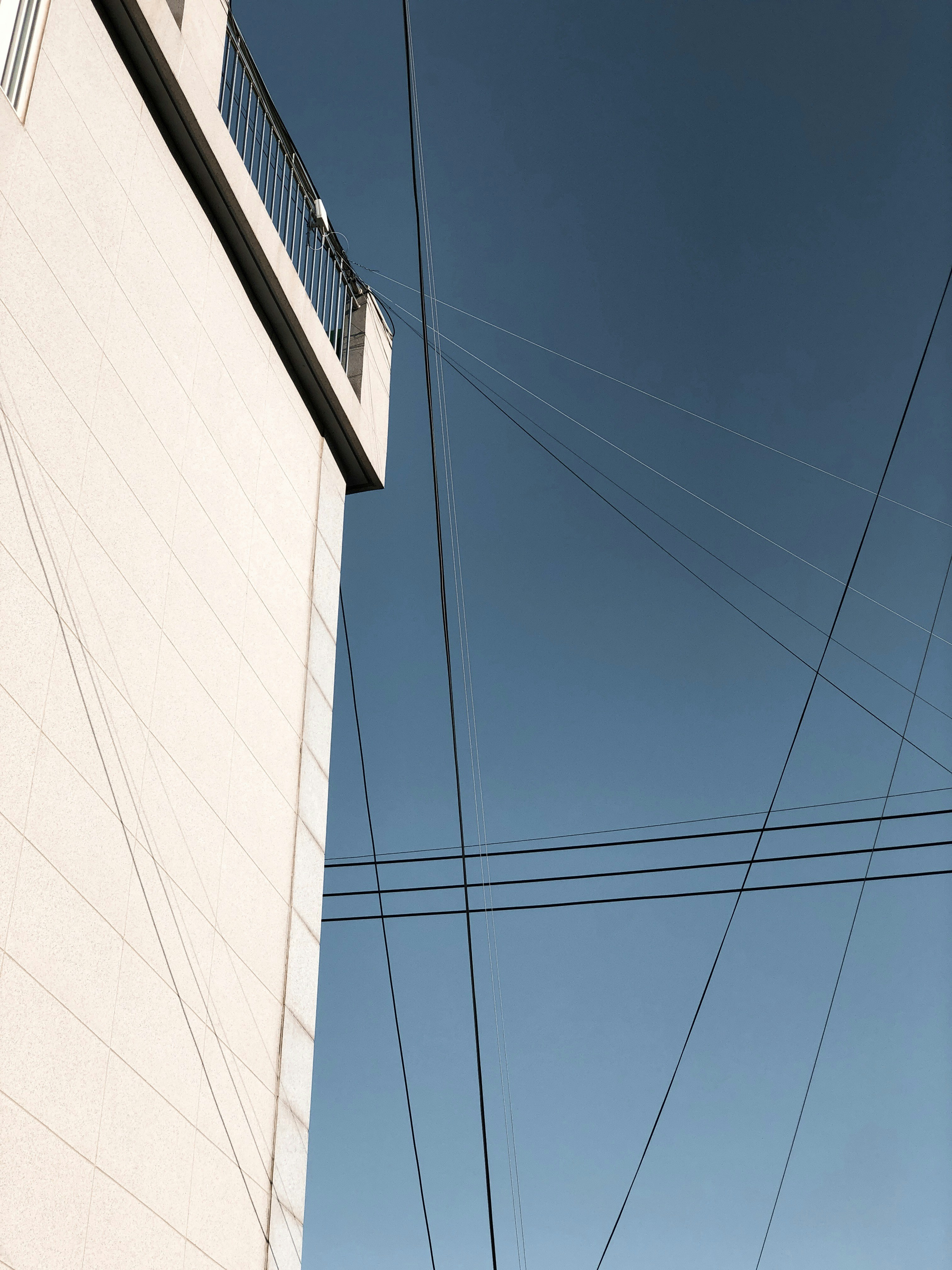 A tall building with power lines above it photo – Free Seoul Image on ...