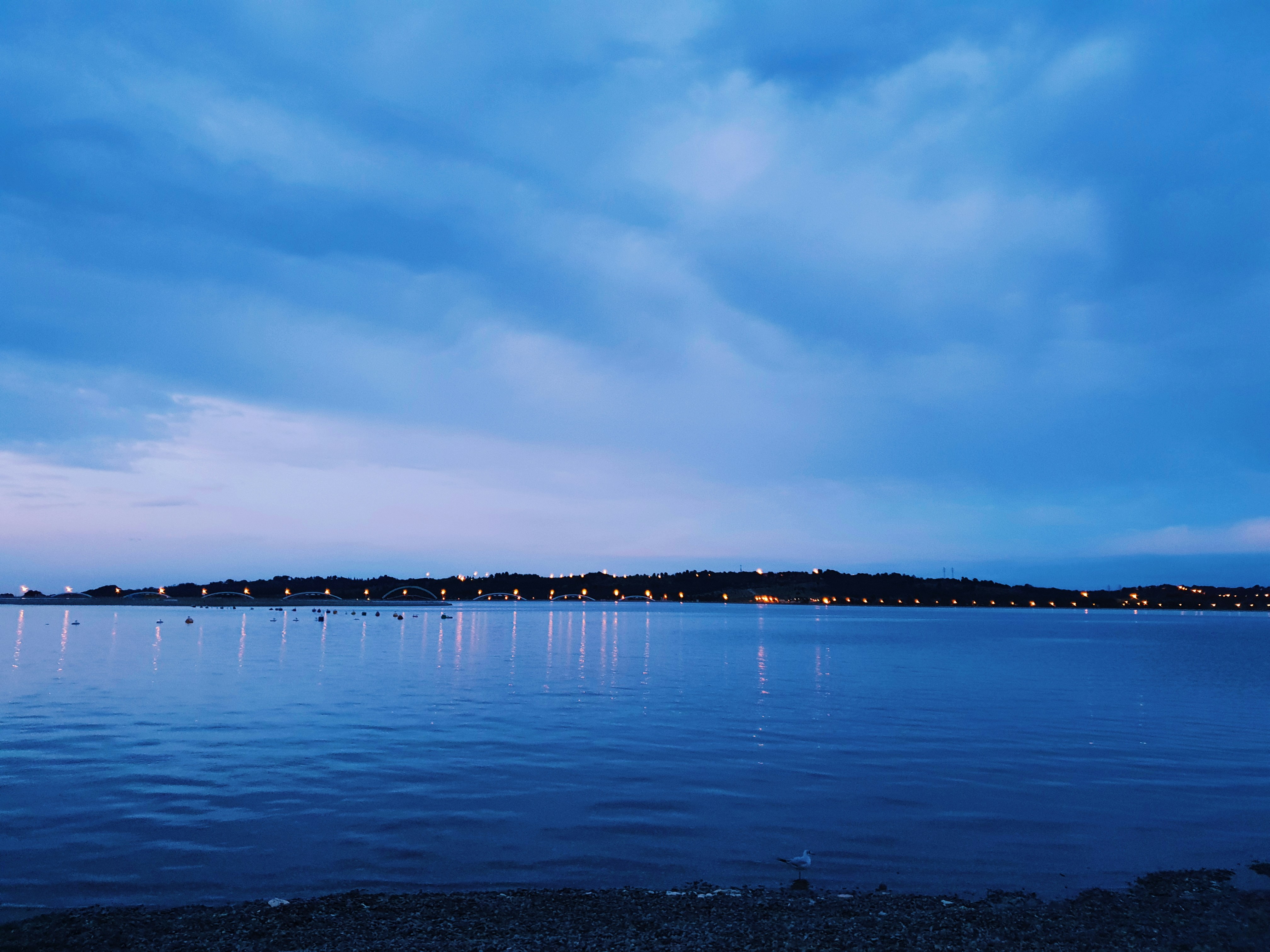 Horizon of Quiet Light over a Velvet Lake at Dusk
