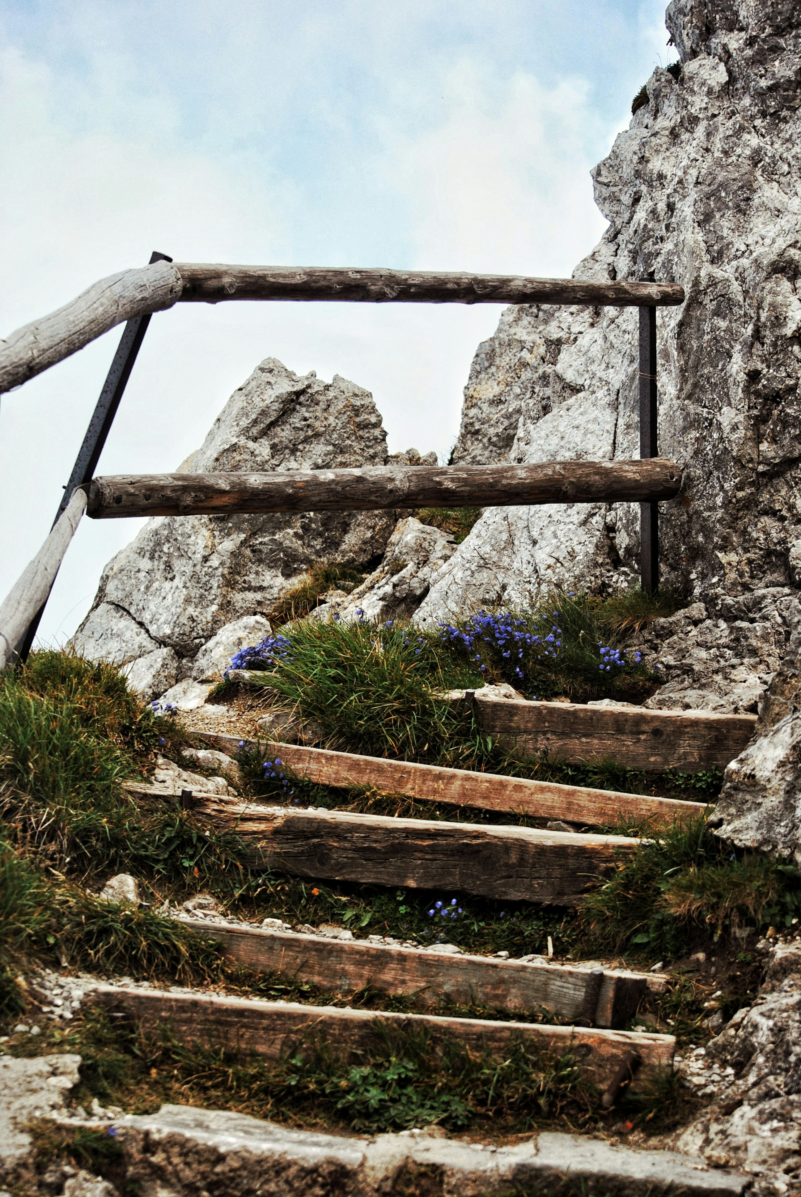 A set of wooden steps leading up to a cliff photo – Free Slate Image on ...