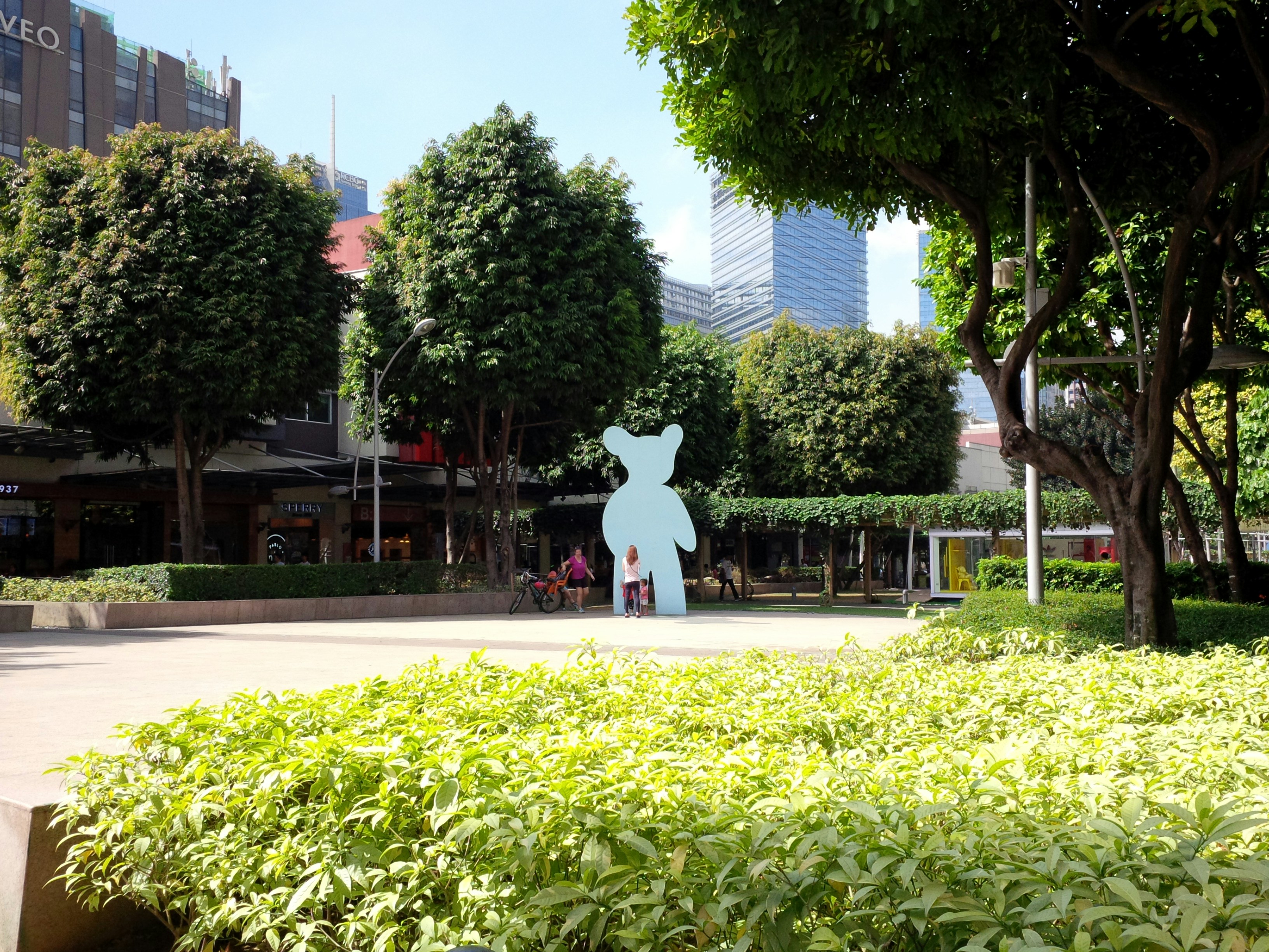 Blue Bear in the Sunlit City Plaza