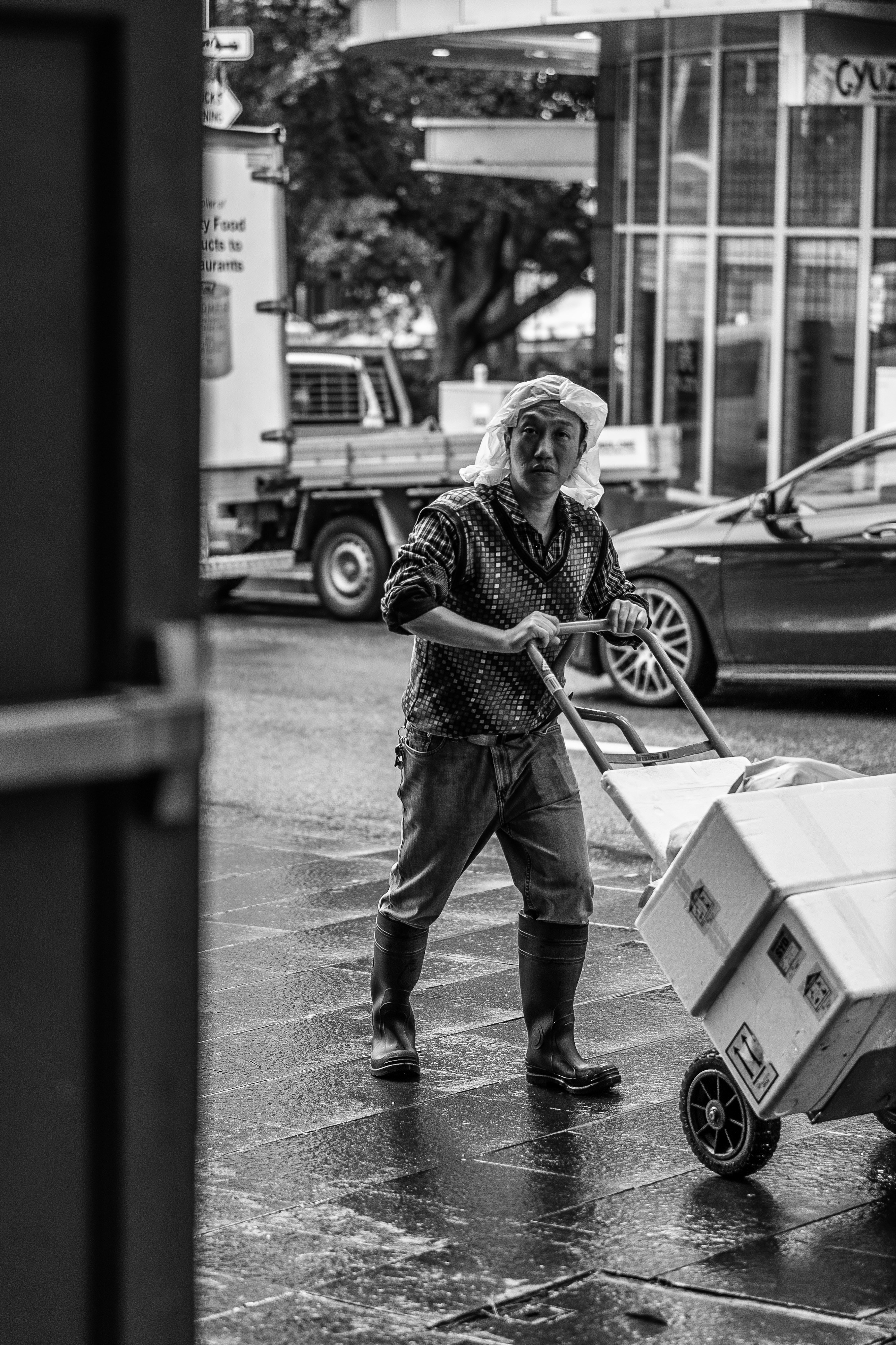 Market Worker in Motion: A Street Scene in Black and White