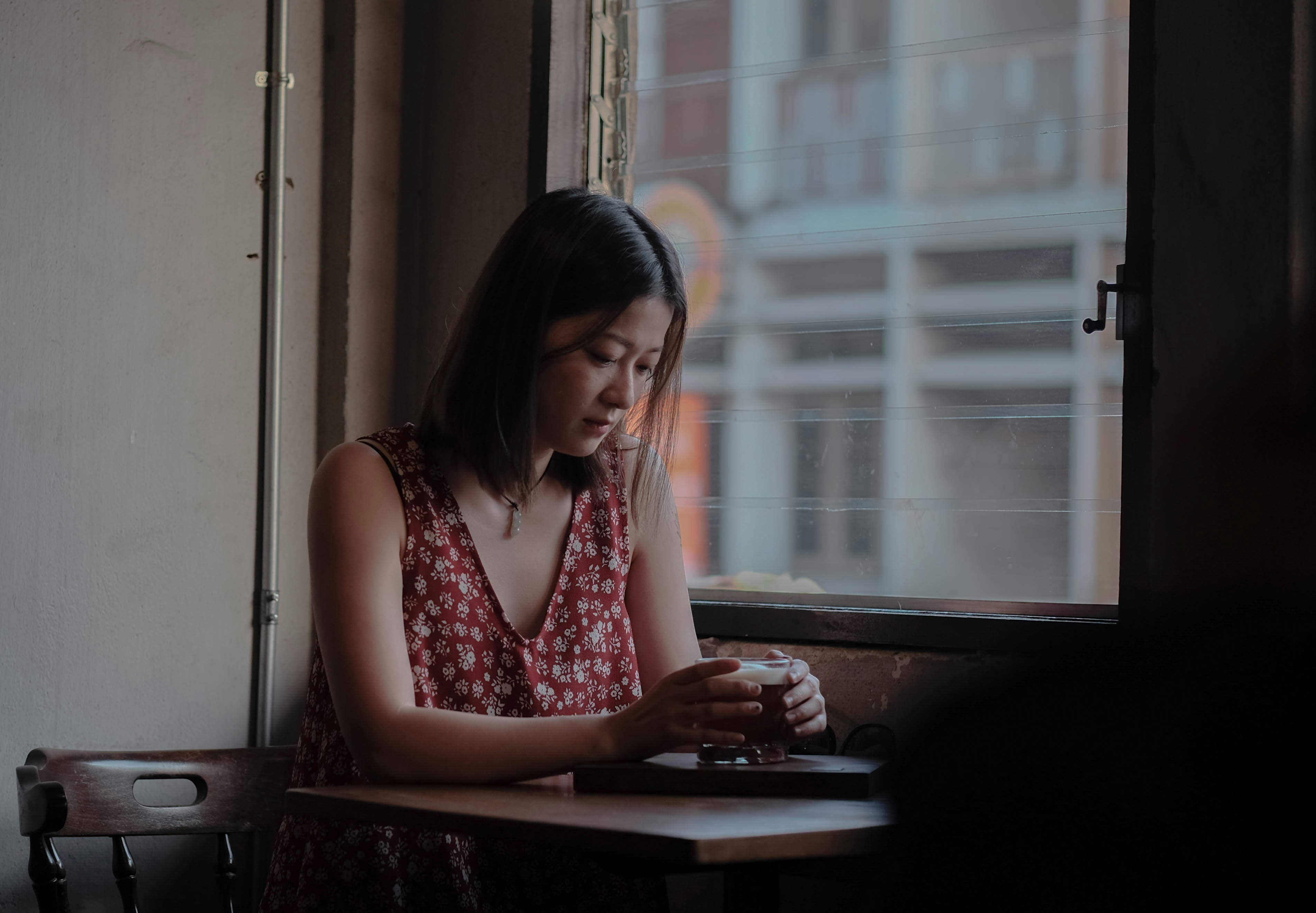 Woman sitting beside window pane photo – Free Grey Image on Unsplash