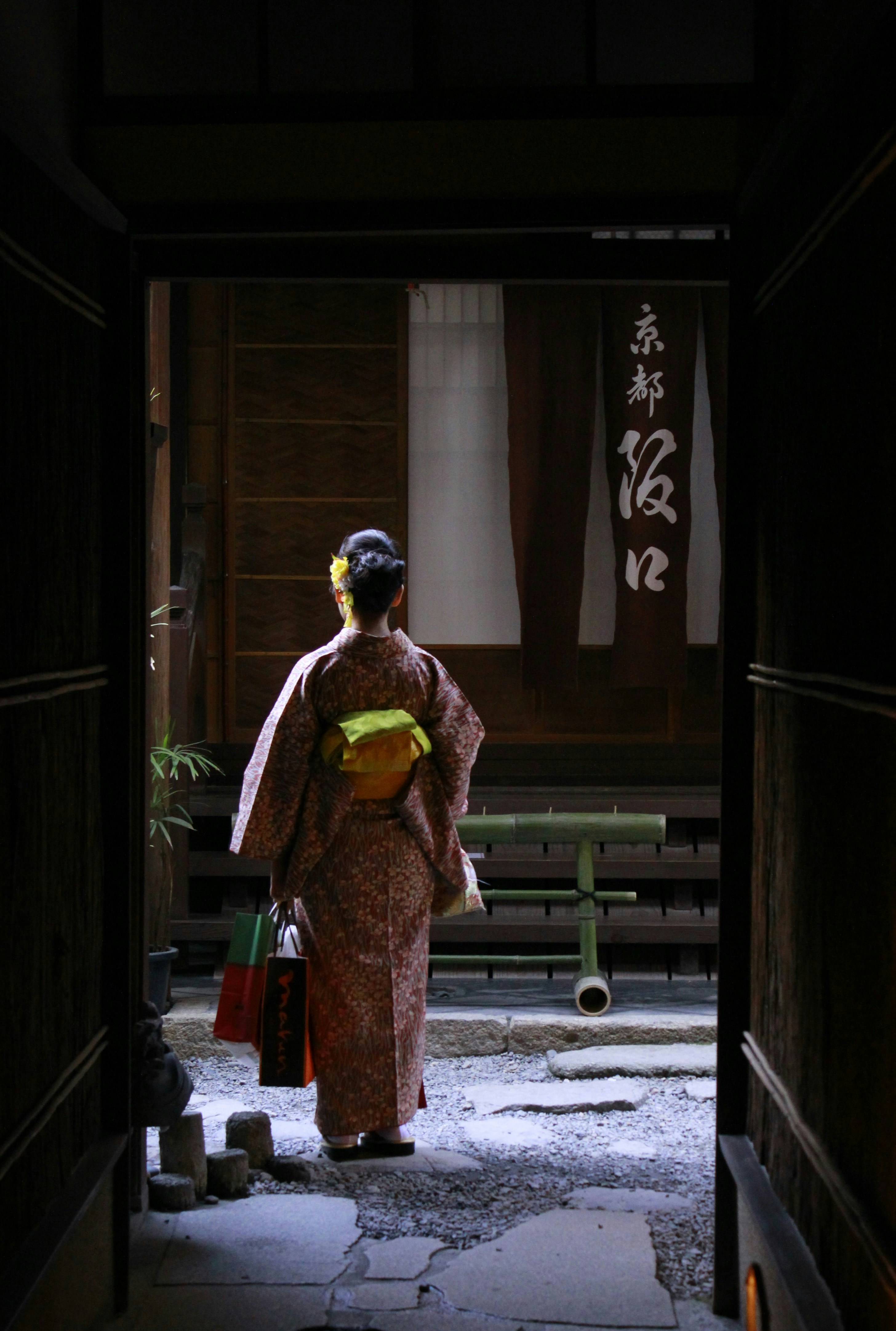 Quiet Corridor, Flourished Kimono: A Woman in a Japanese Courtyard