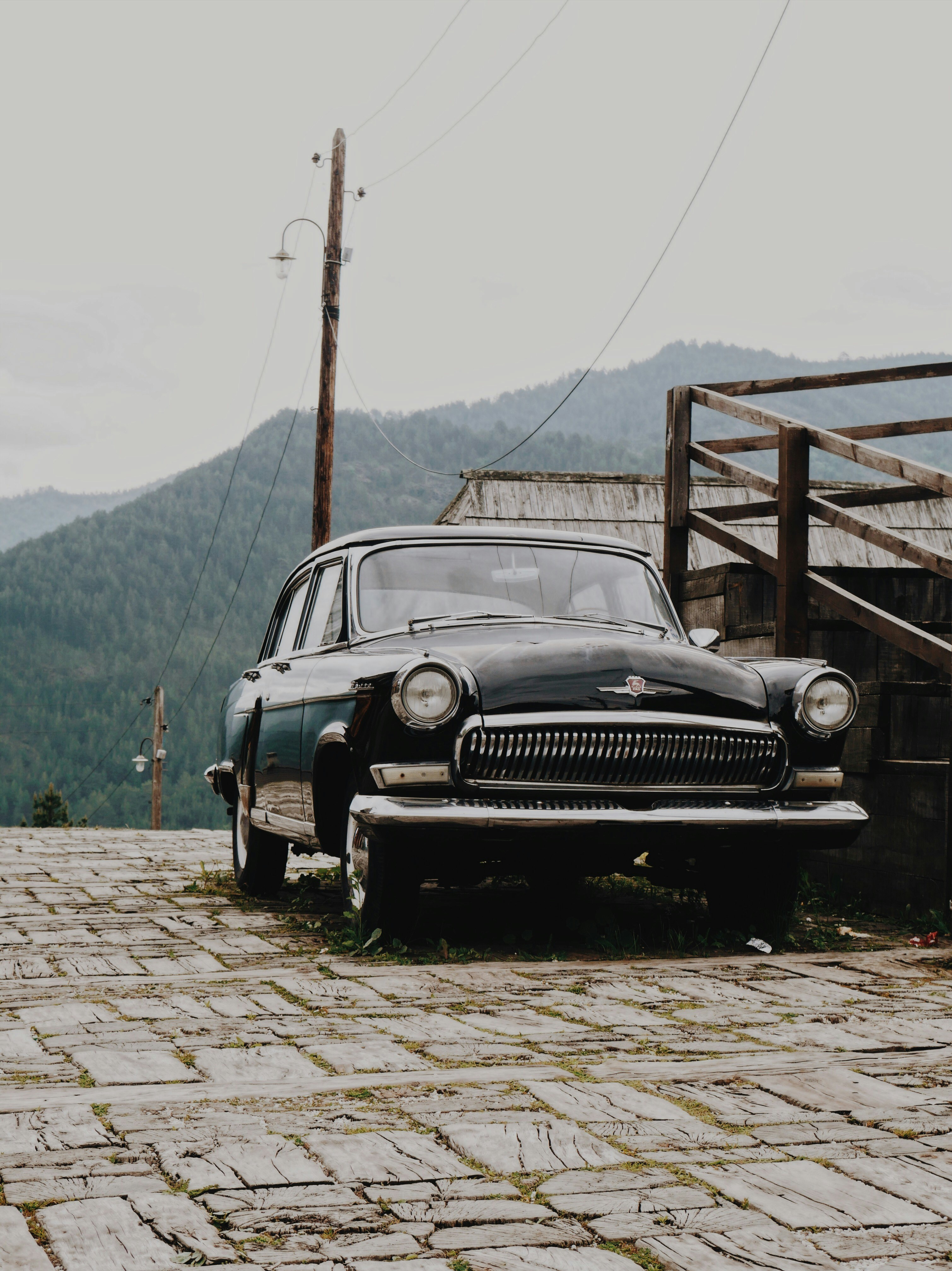 Black classic car parked beside brown wooden railing photo – Free Car ...