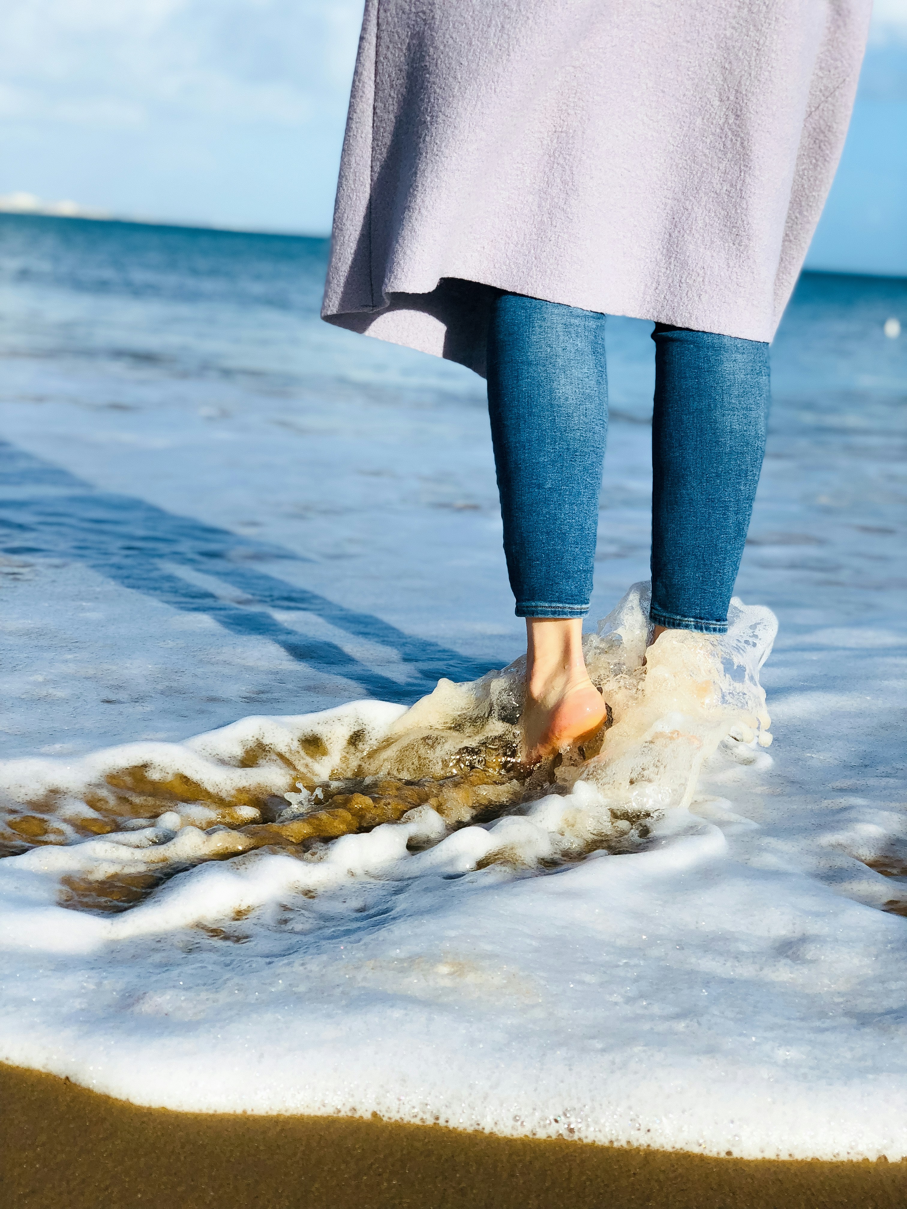 Feet in the Tide: A Barefoot Walk Along Lapping Shoreline
